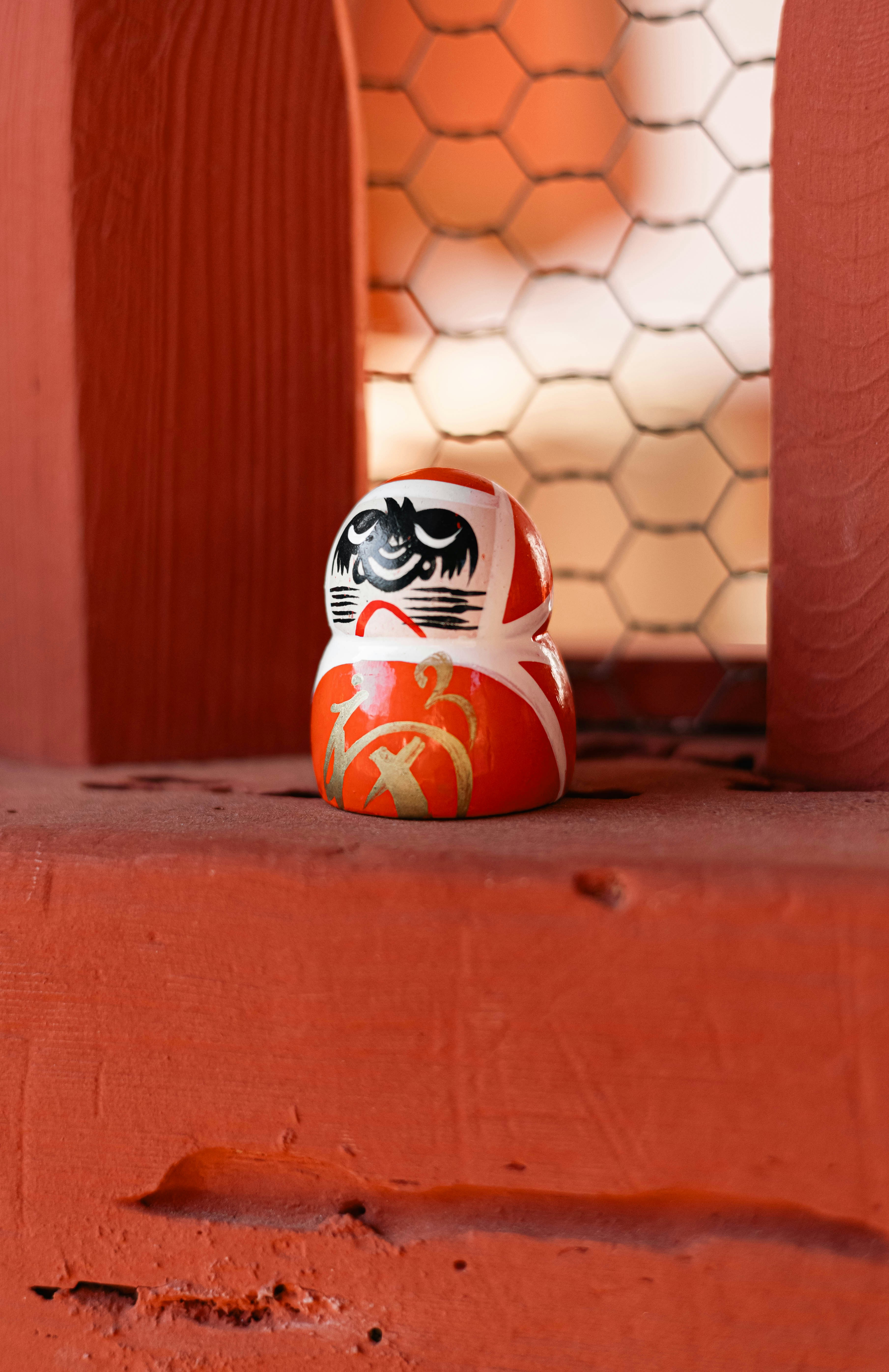 Daruma on Red Steps: A Small Silent Figure in a Geometric Glaze