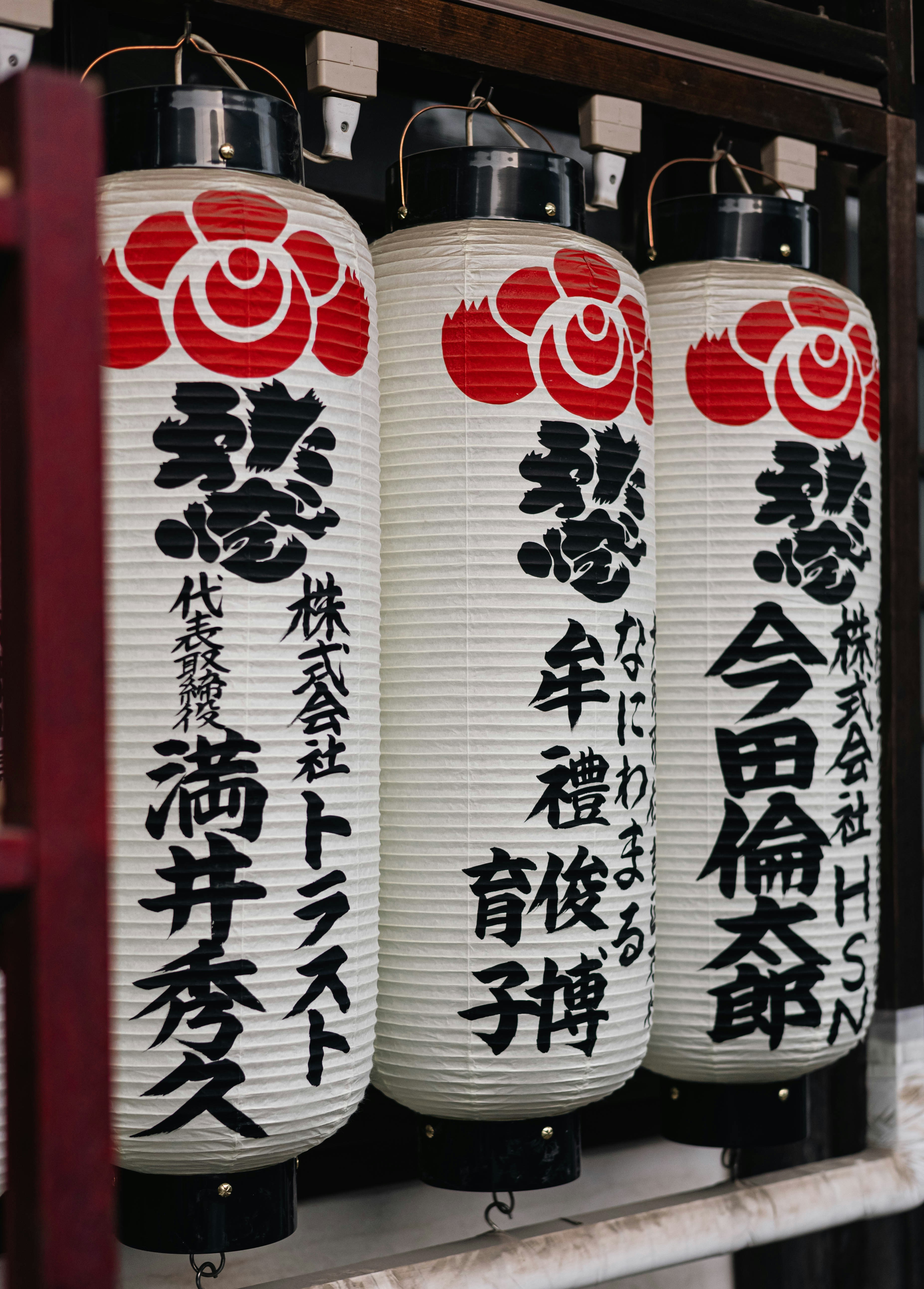 Three Lanterns in a Row: Bold Calligraphy and Red Crest