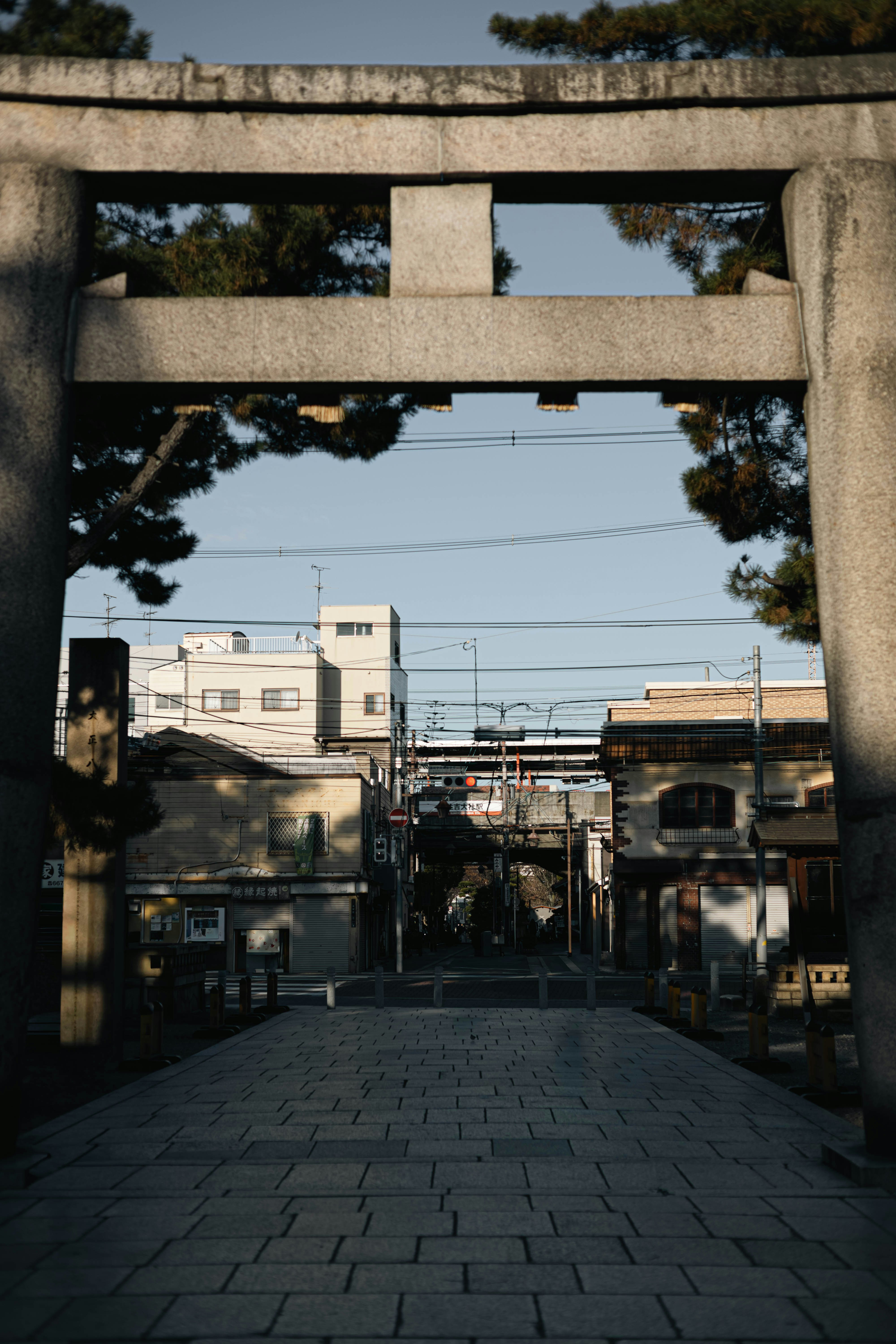 Through the Torii: A Quiet Japanese Street Framed by Stone Columns