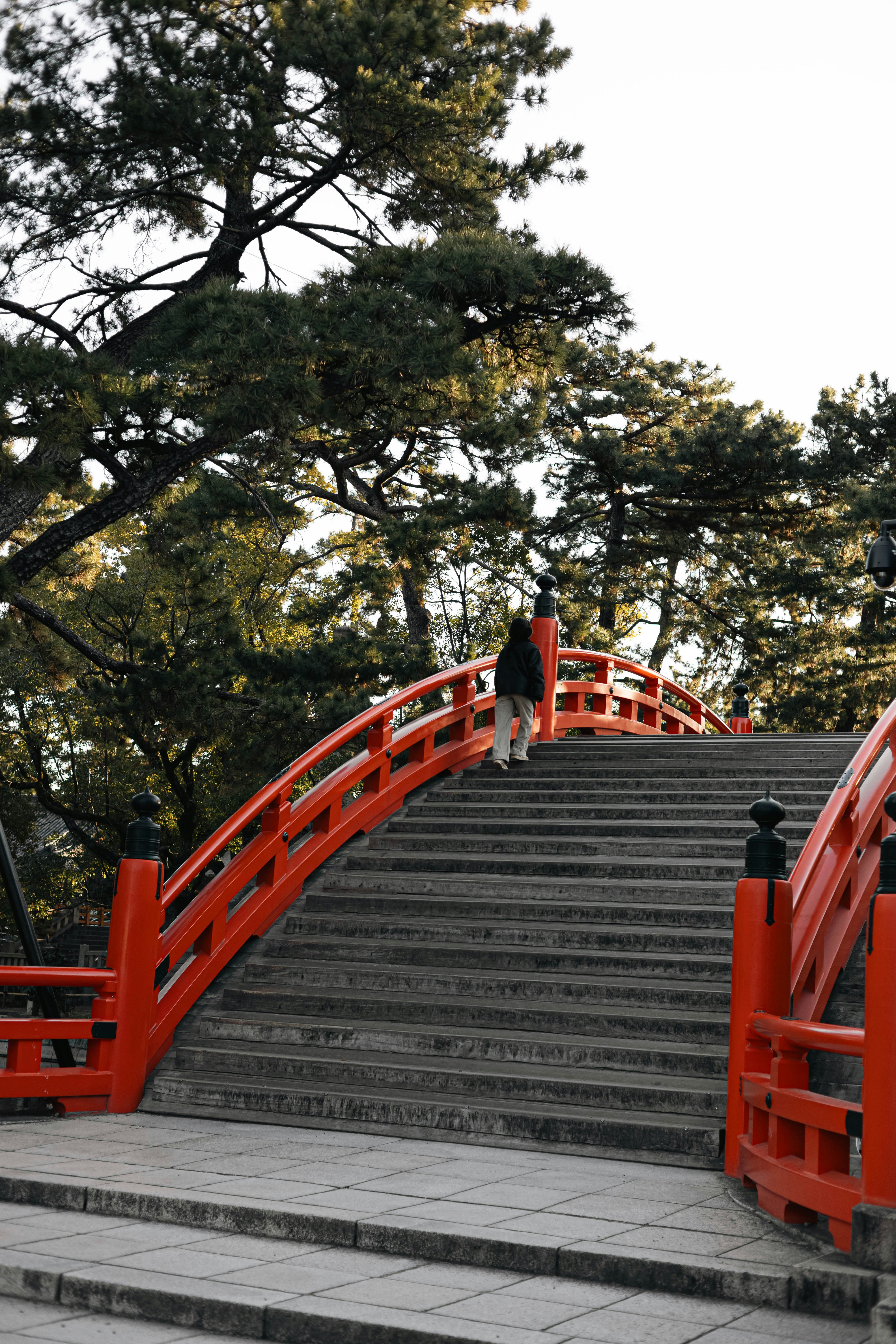 Red Archway Over Stone Steps: A Moment of Quiet on a Park Bridge