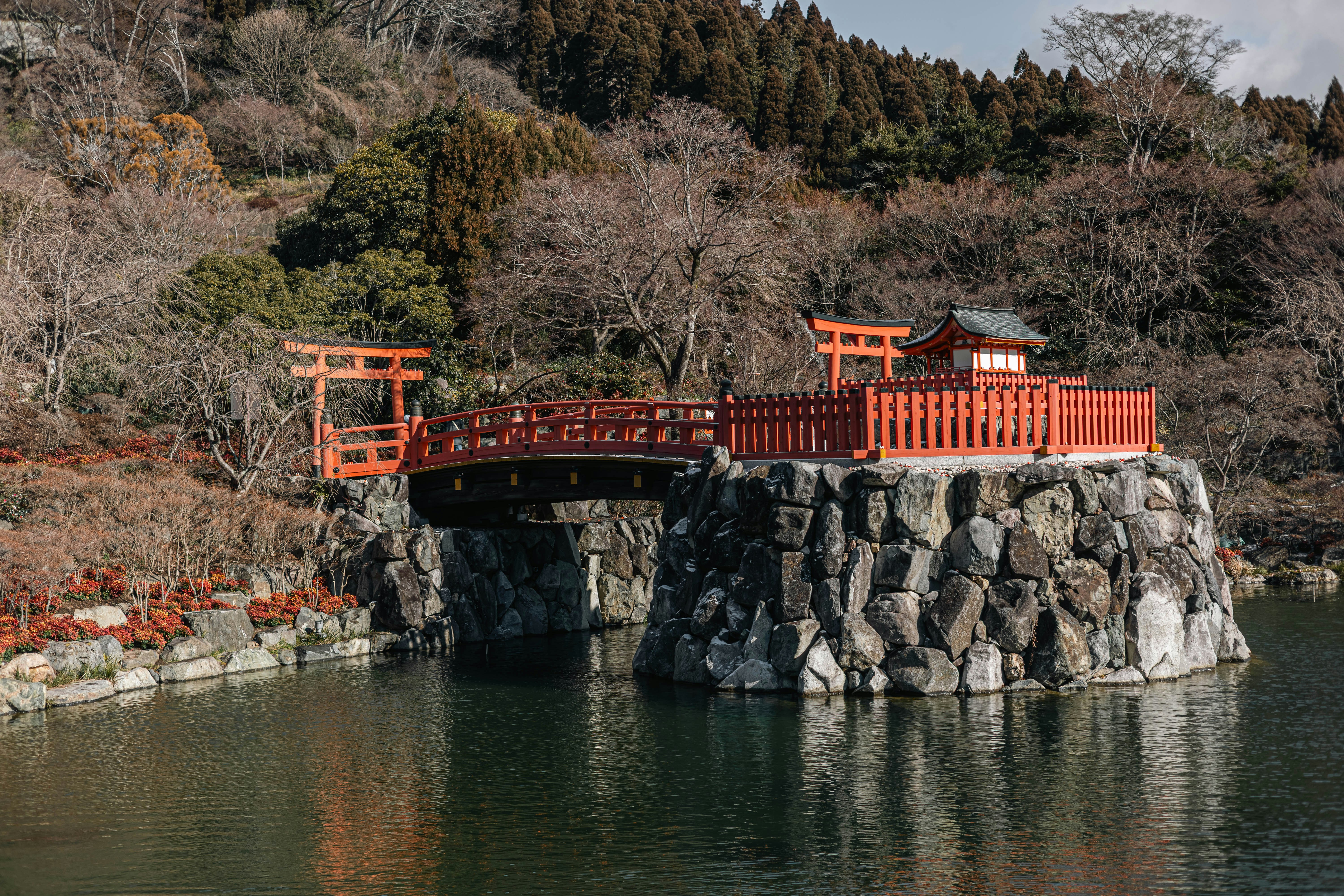 Scarlet Shrine on Stone Island: A Red Bridge Framed by Autumn Shore