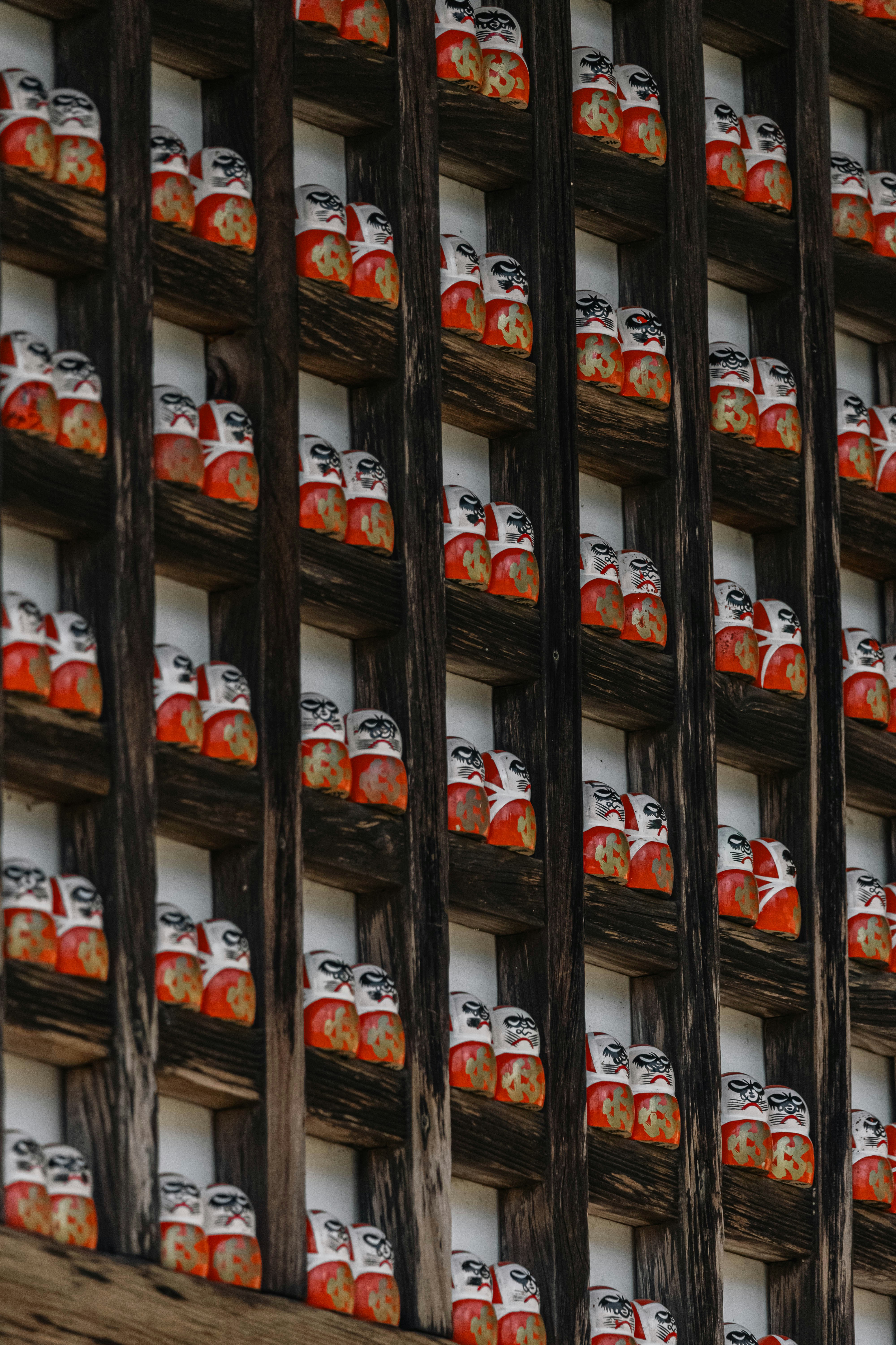 Rows of Cozy Daruma Dolls Fill a Sacred Lattice