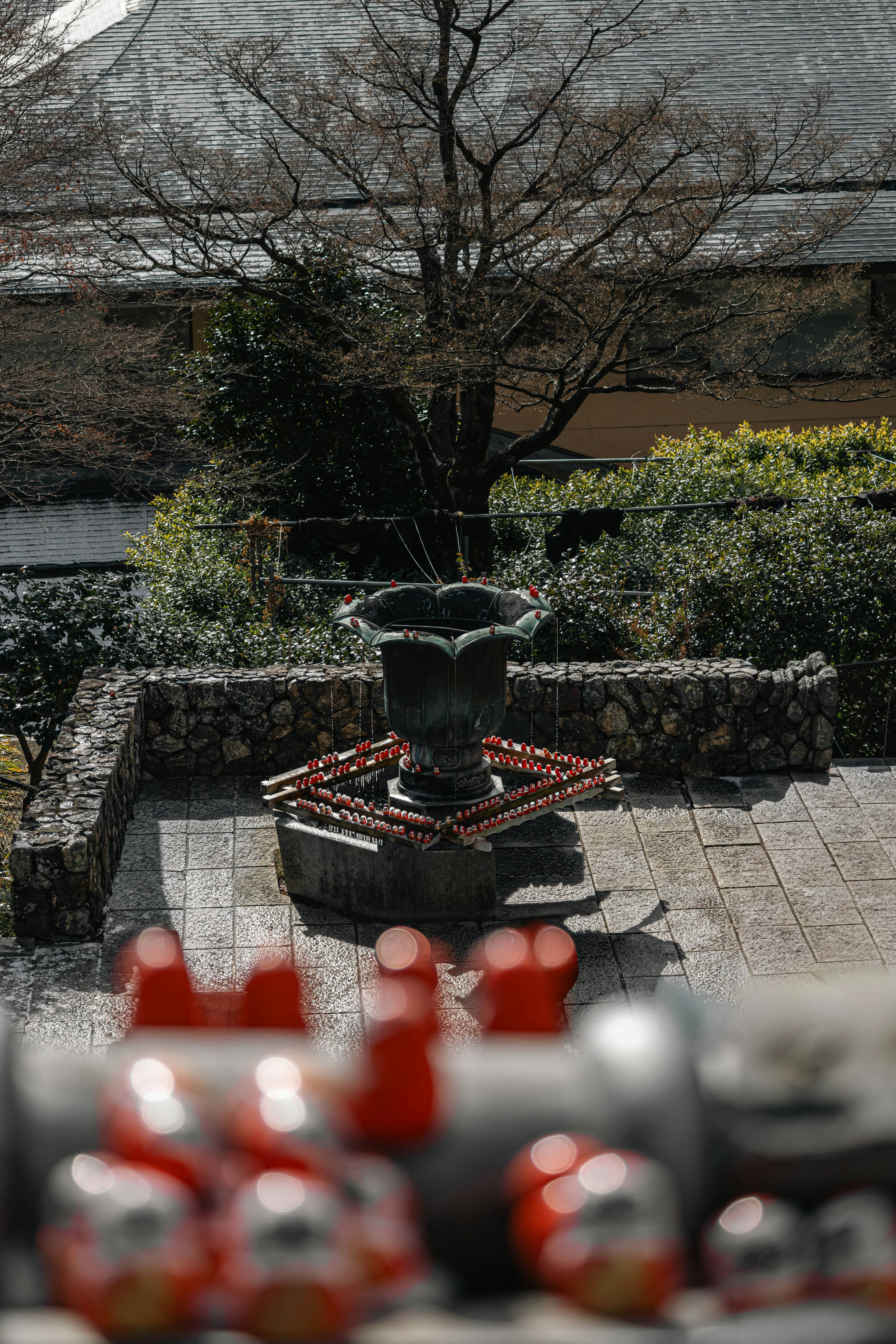 Sacred Courtyard Fountain Framed by Blurred Foreground Ornaments