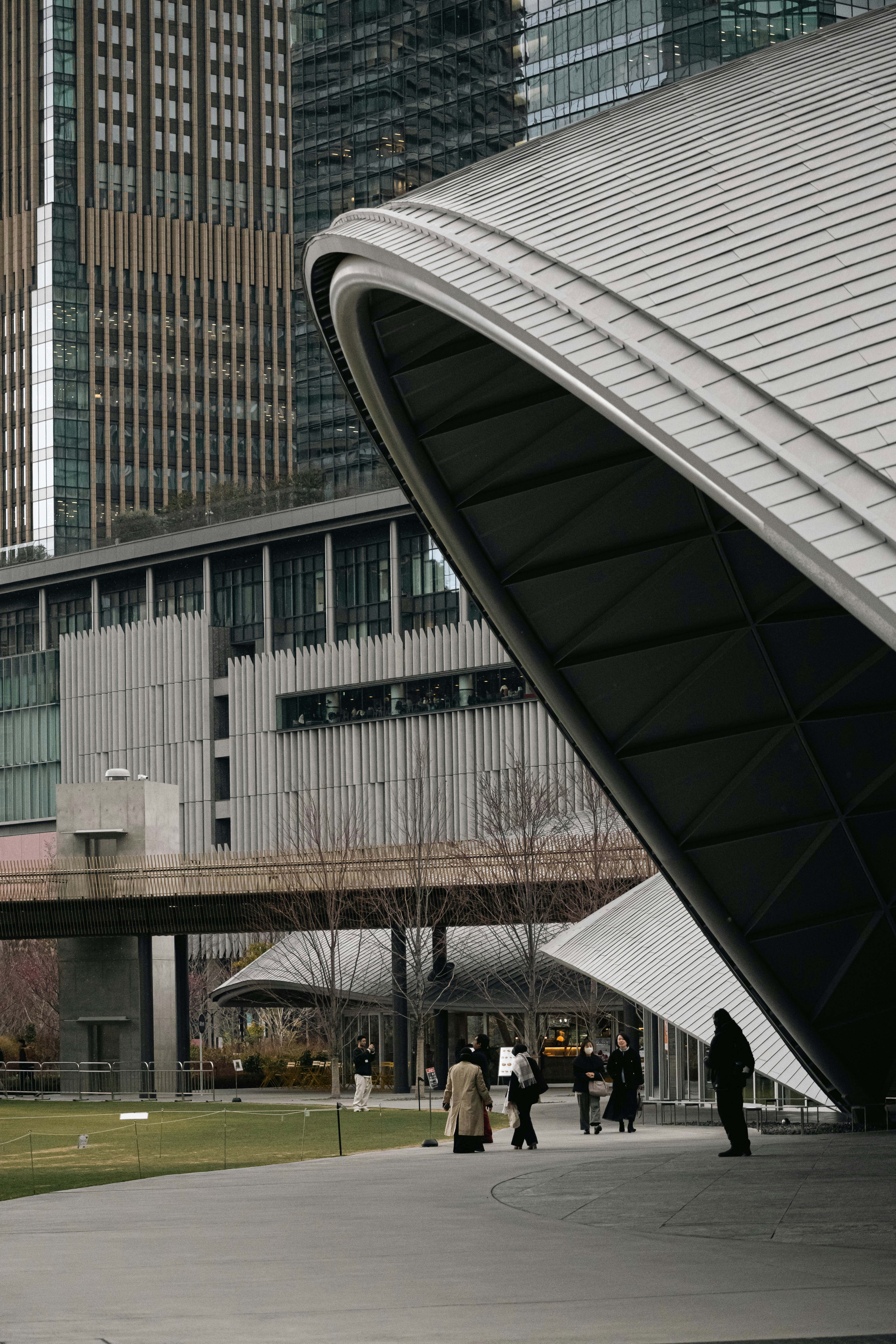 Arc of Steel and Sky Over a City Plaza
