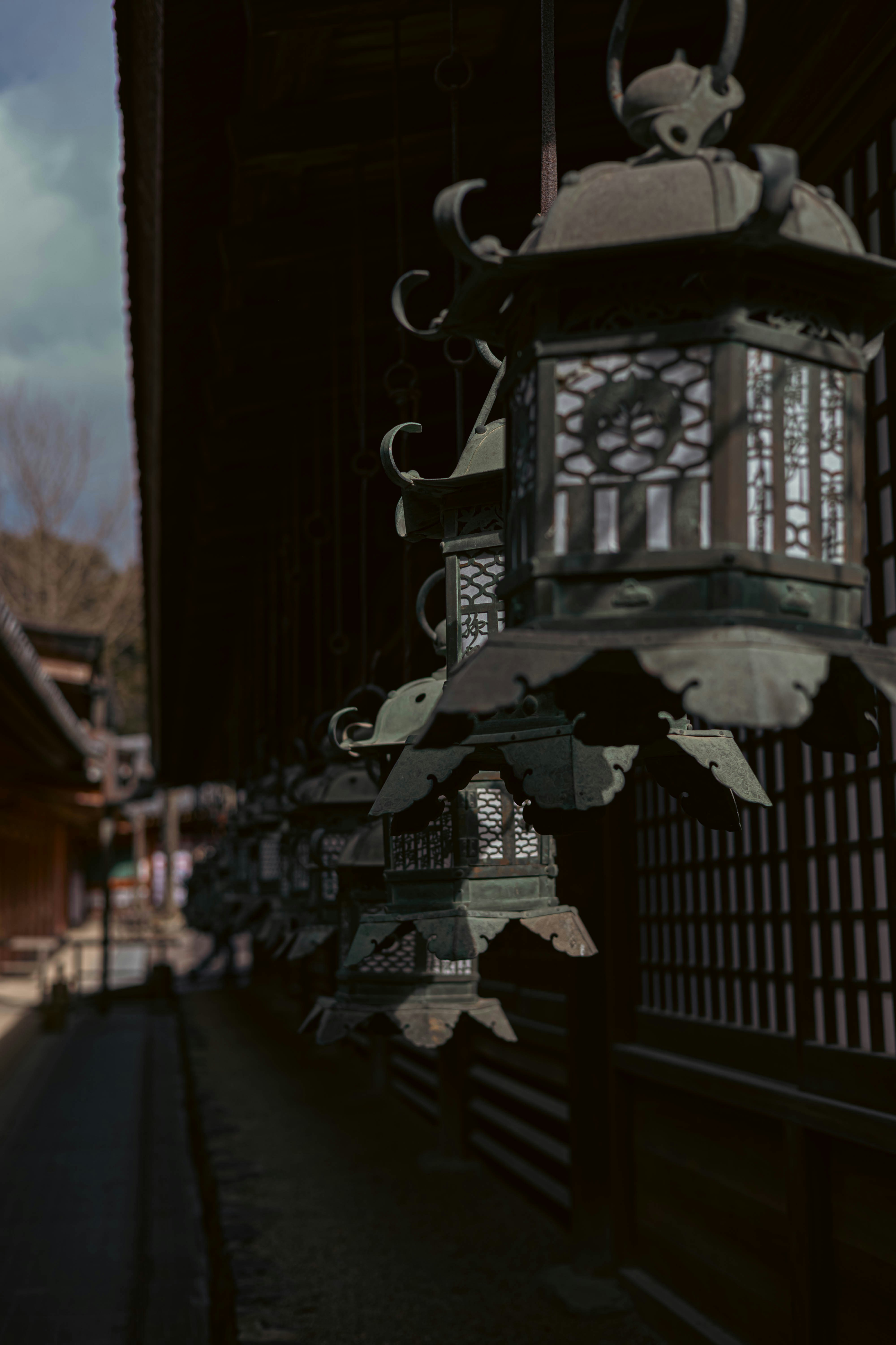 Ornate lanterns in a quiet temple corridor