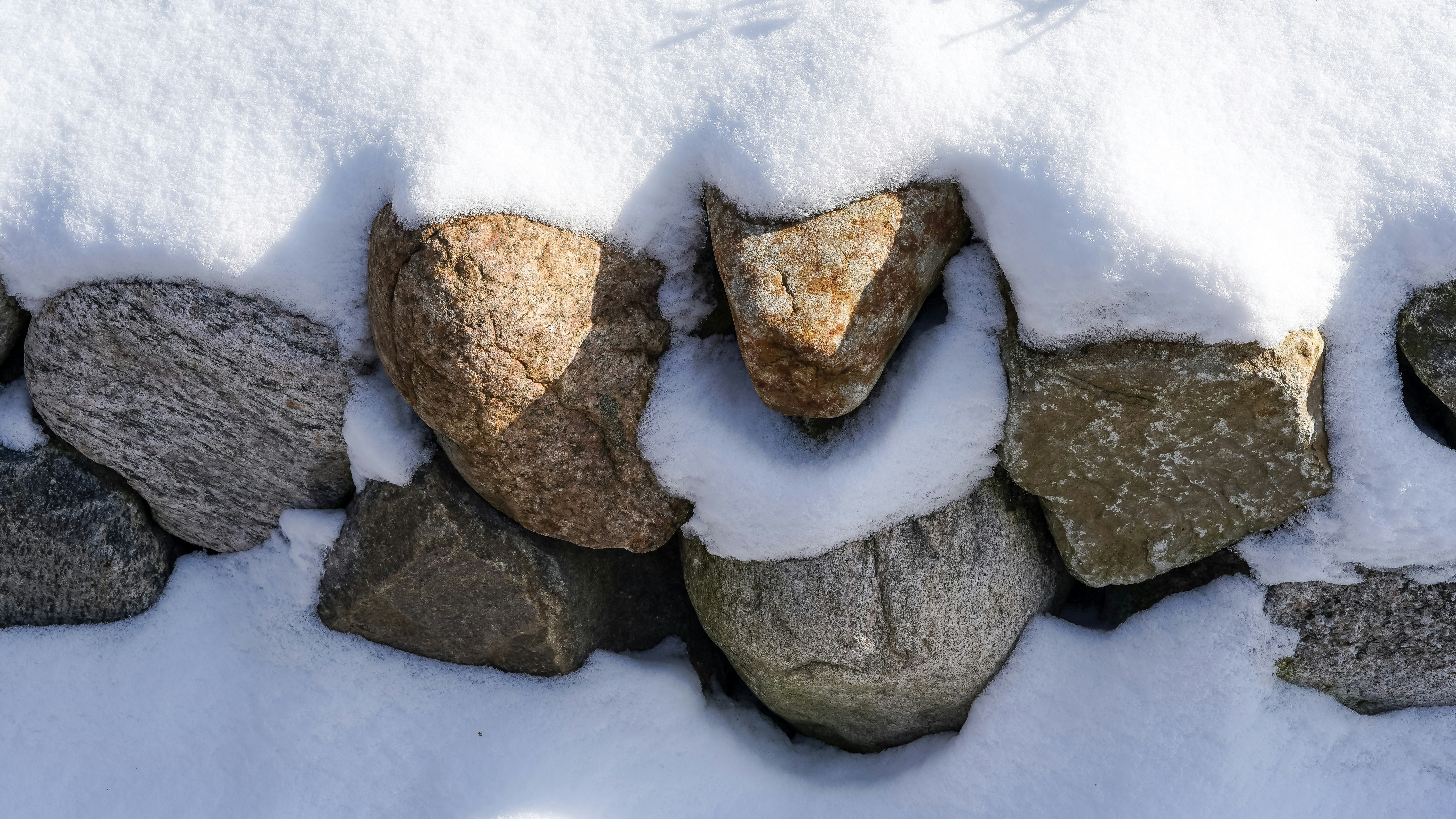 Snow-Cressed Rubble: A Quiet Stone Row Under Winter Light