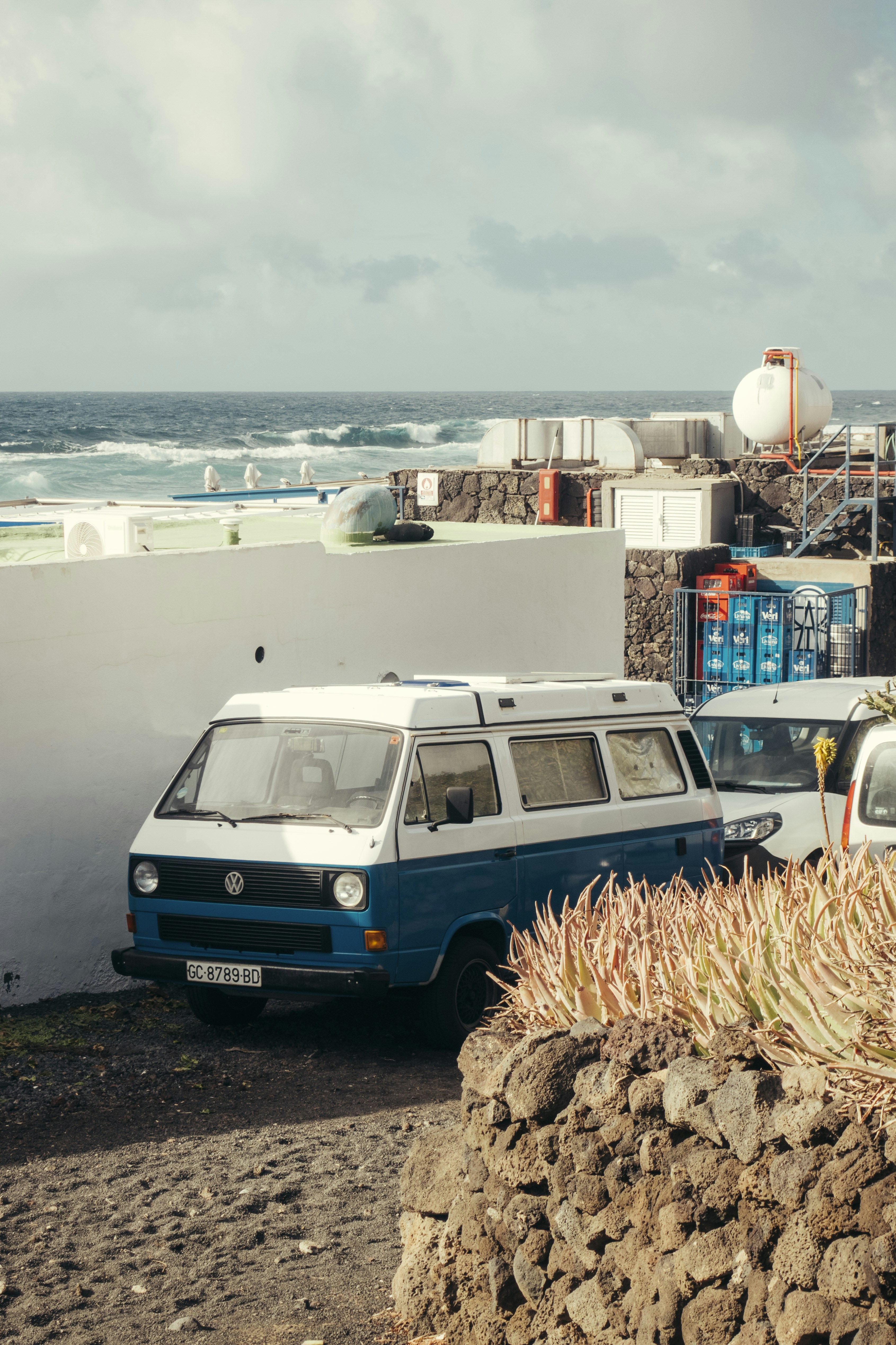 Blue Van at the Coastal Lot with Ocean Backdrop