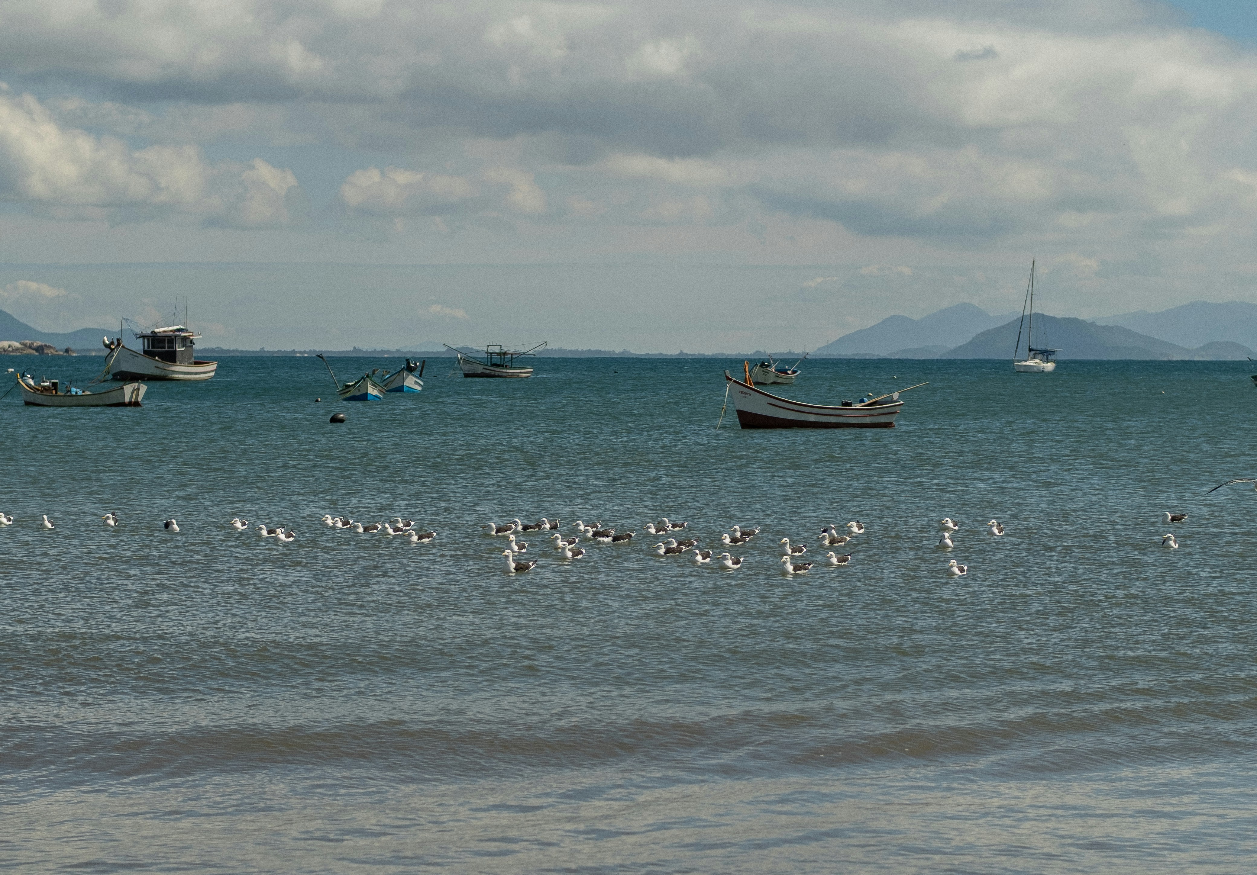Boats at Distant Horizon Beneath Patchy Clouds