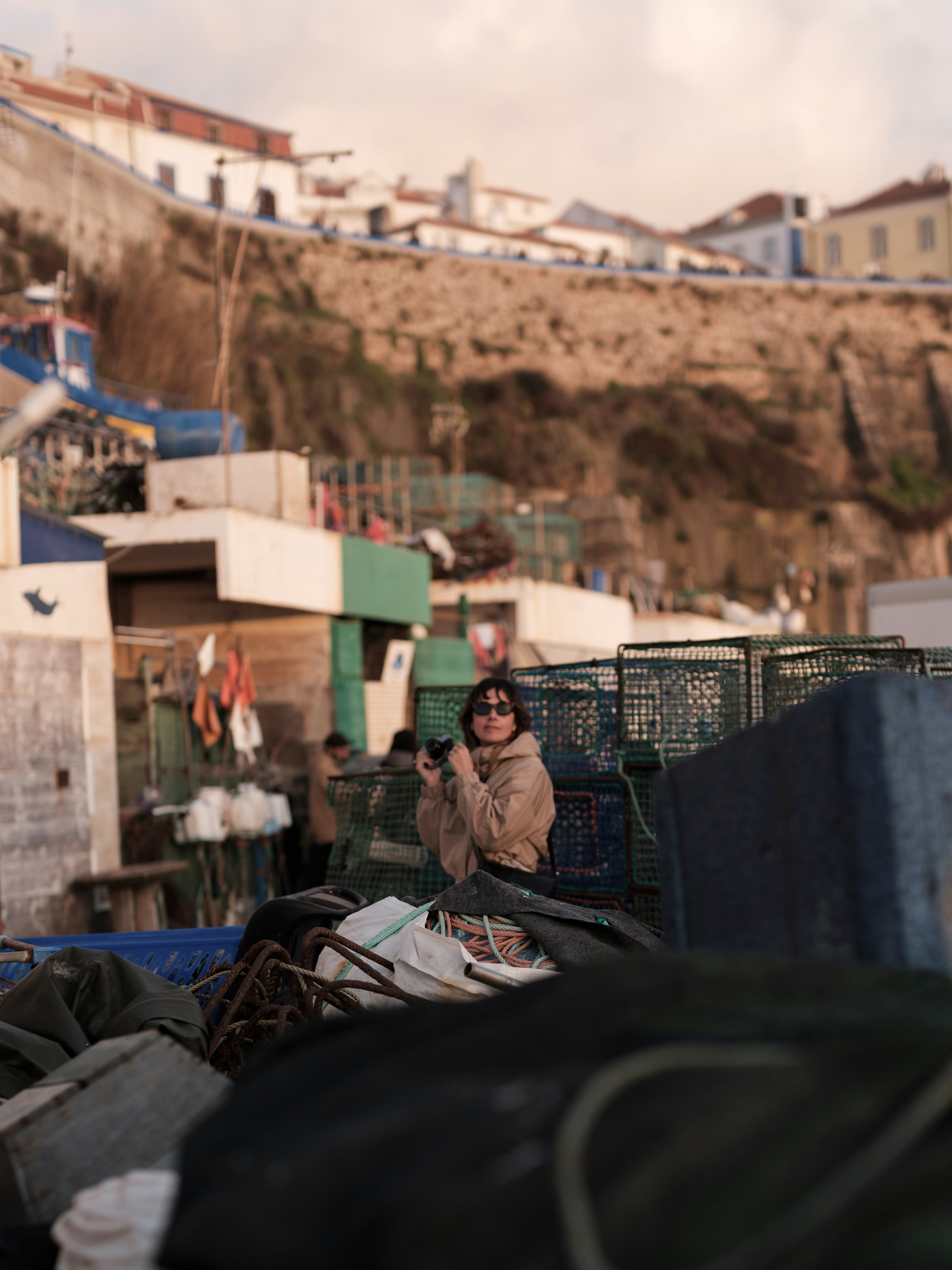 Lens on the Fisherwoman: Street Portrait Amid Maritime Clutter