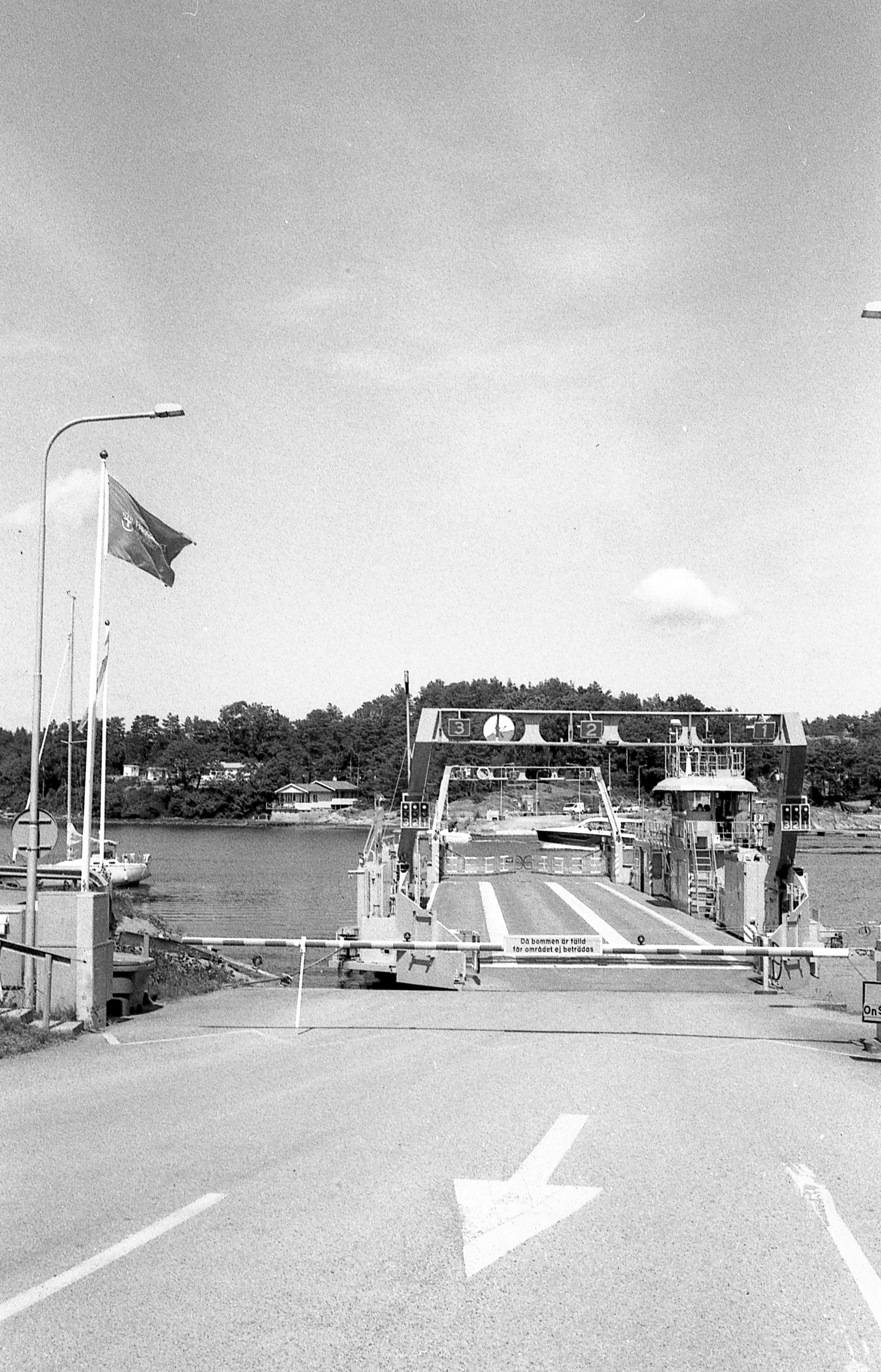 A ferry boat docked at a pier with a ramp