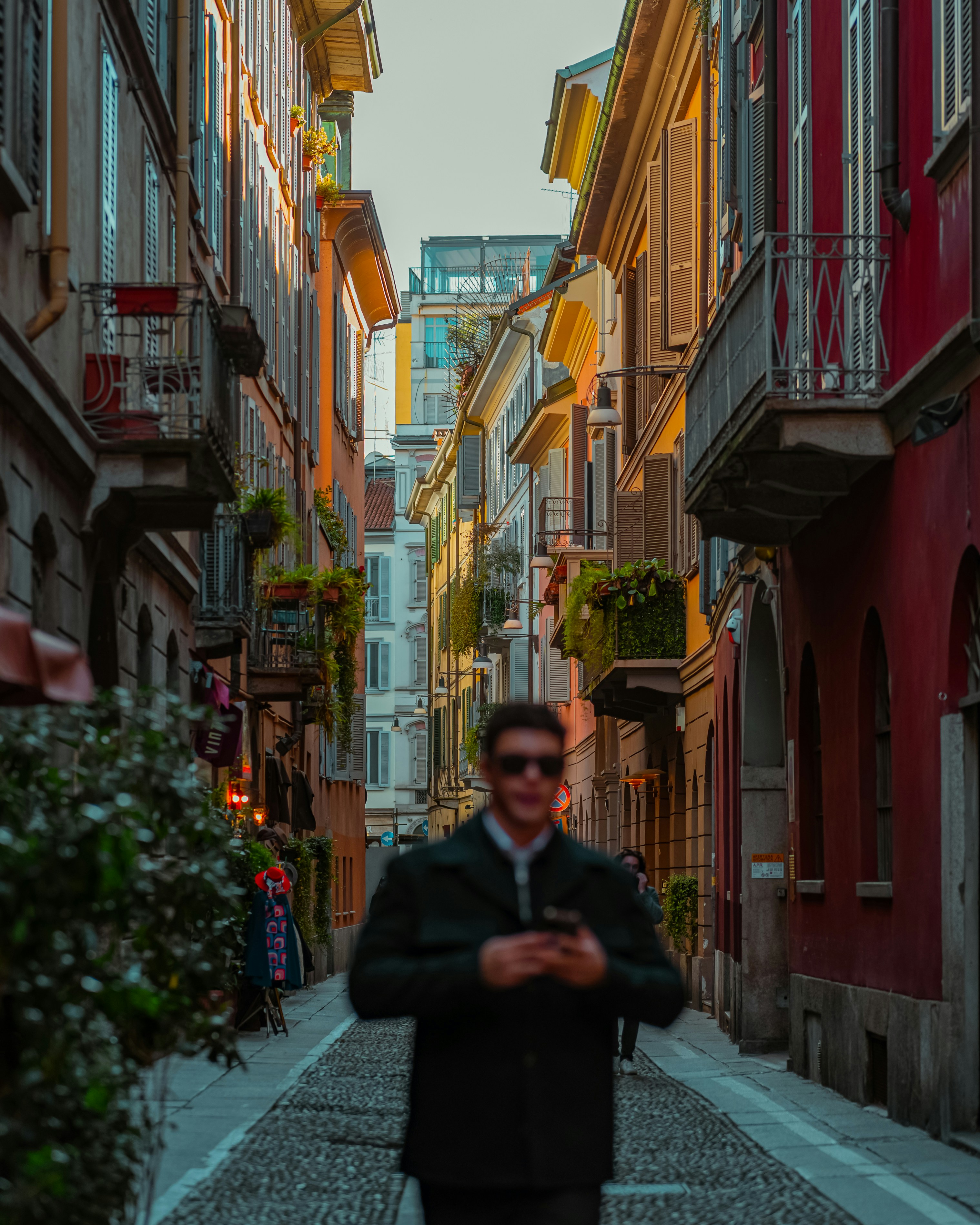 Blurred Stranger in a Sunlit Alleyway
