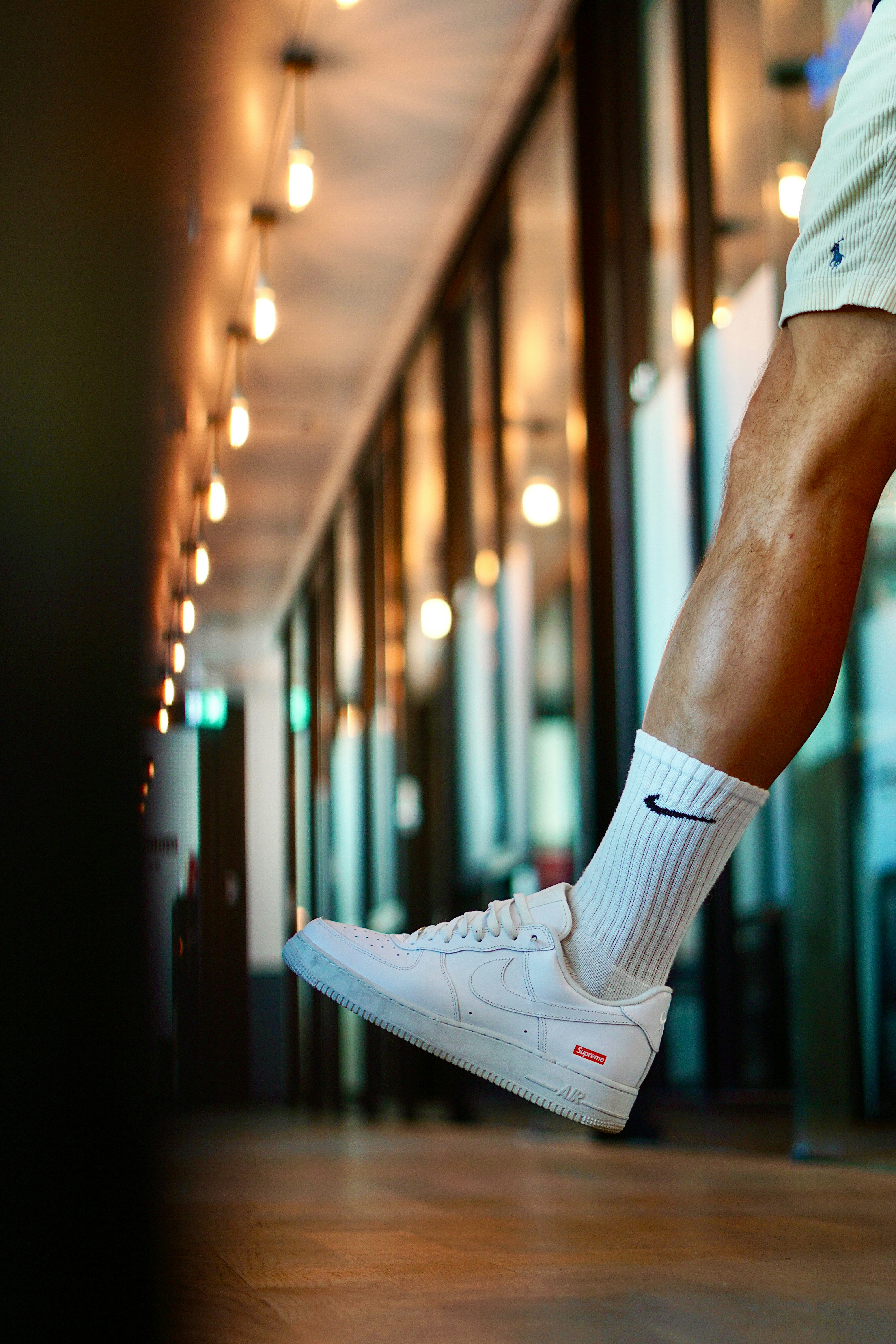 Stride in the Hall: White Nike Sneaker Hangs in Motion