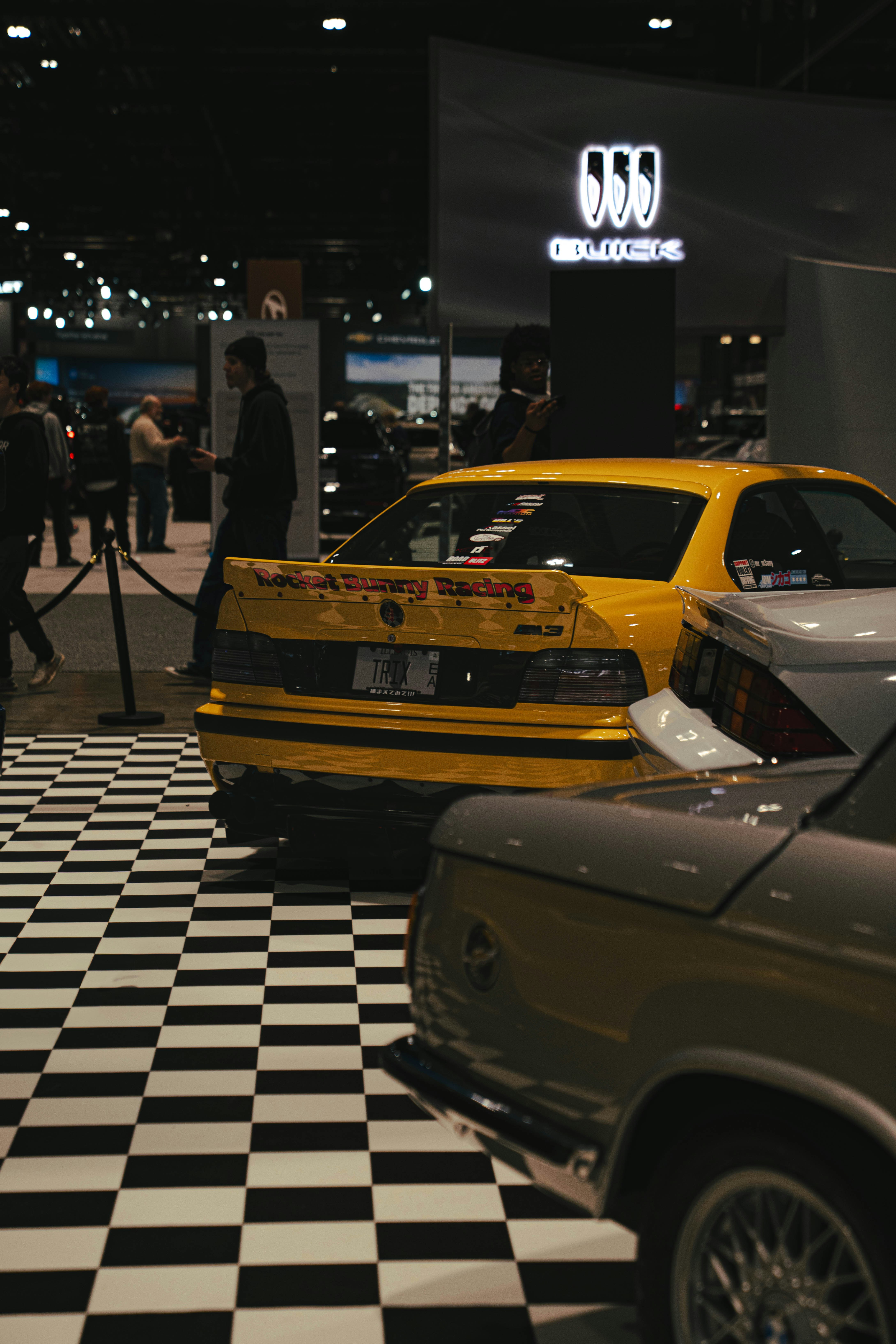 Yellow Racing Car at a Dim Car Show Floor
