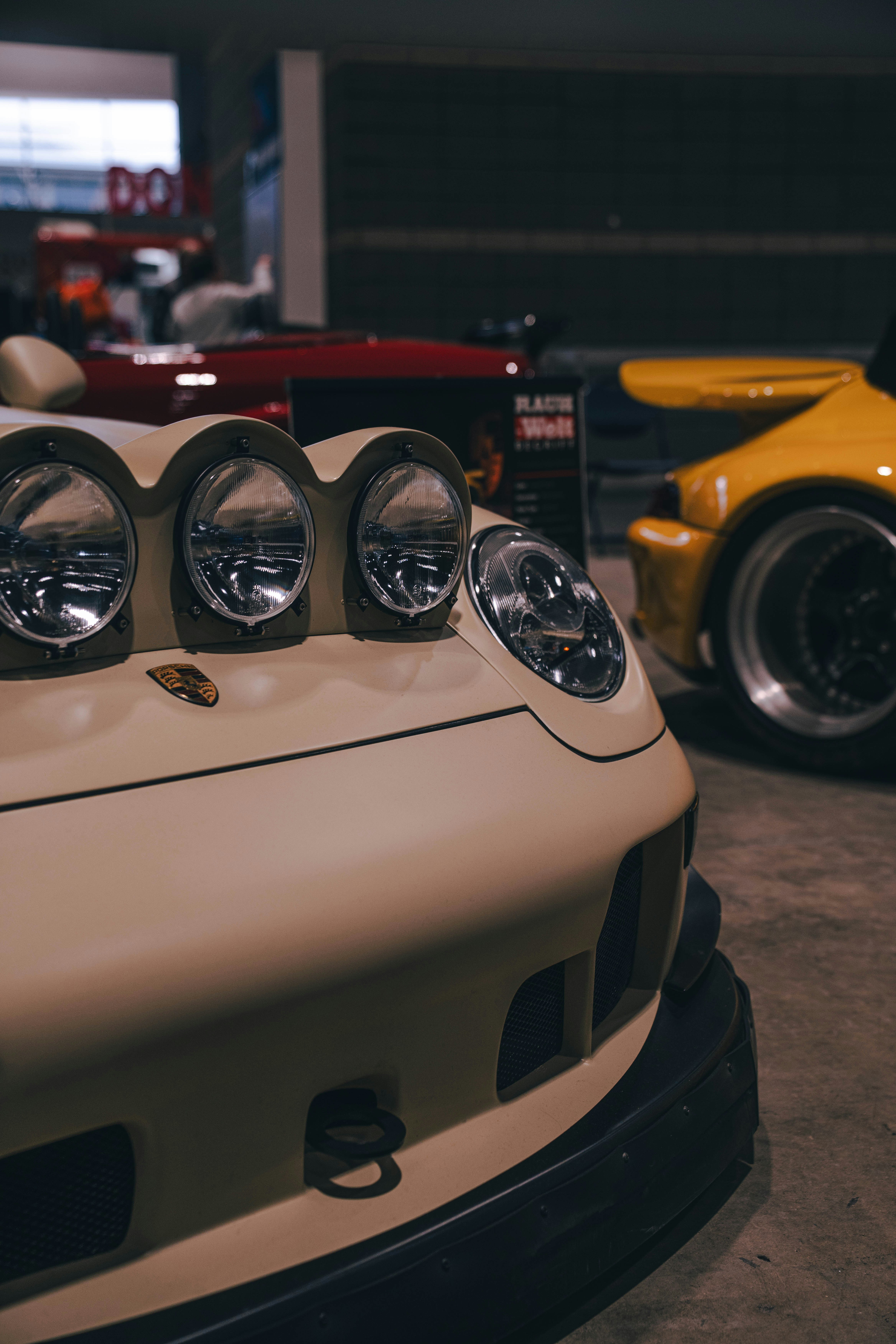 Headlights in Focus: A Porsche Front and the Quiet Crowd of Car Stories