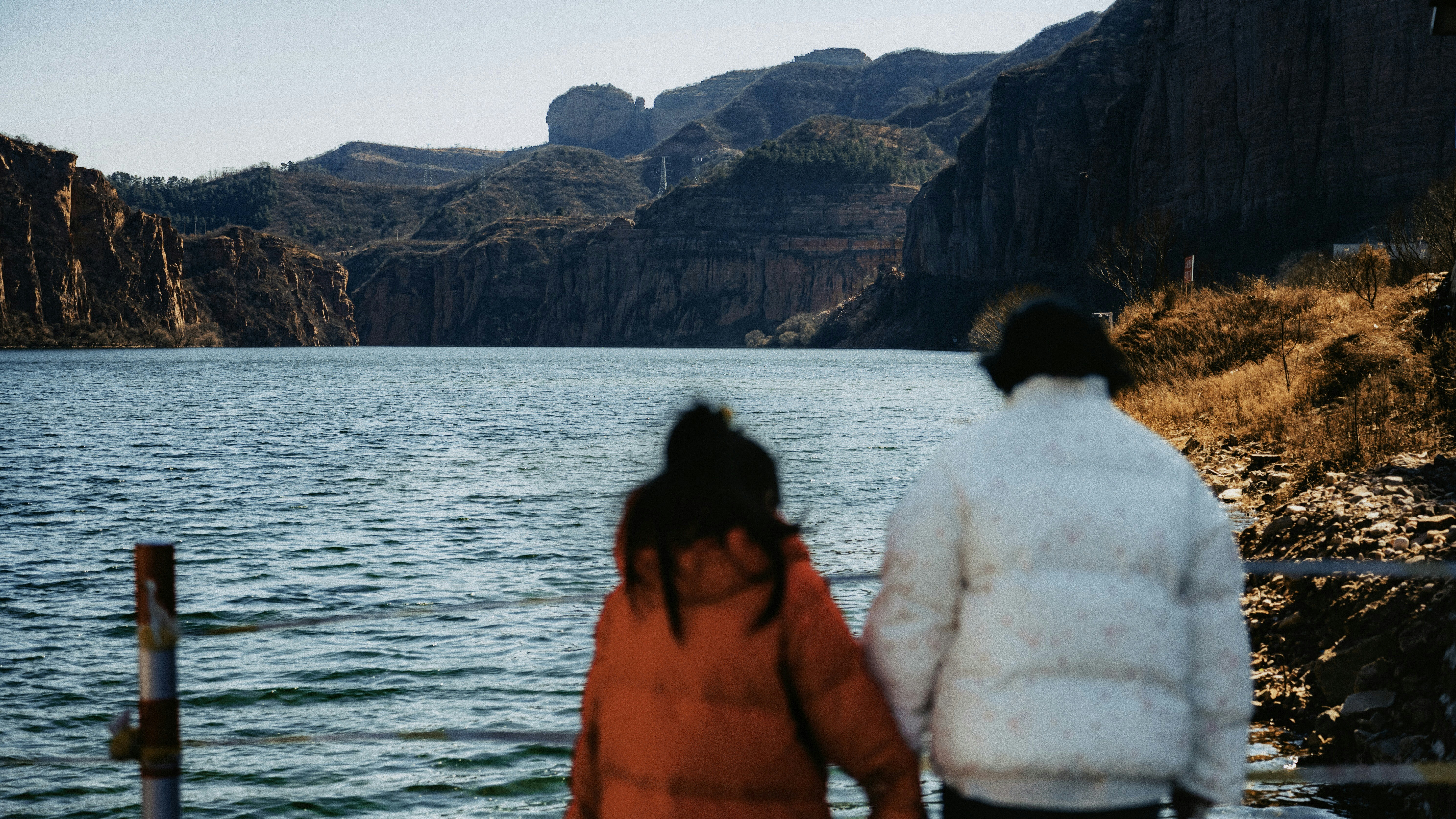 Two Warm Figures at the Cliffside Shore
