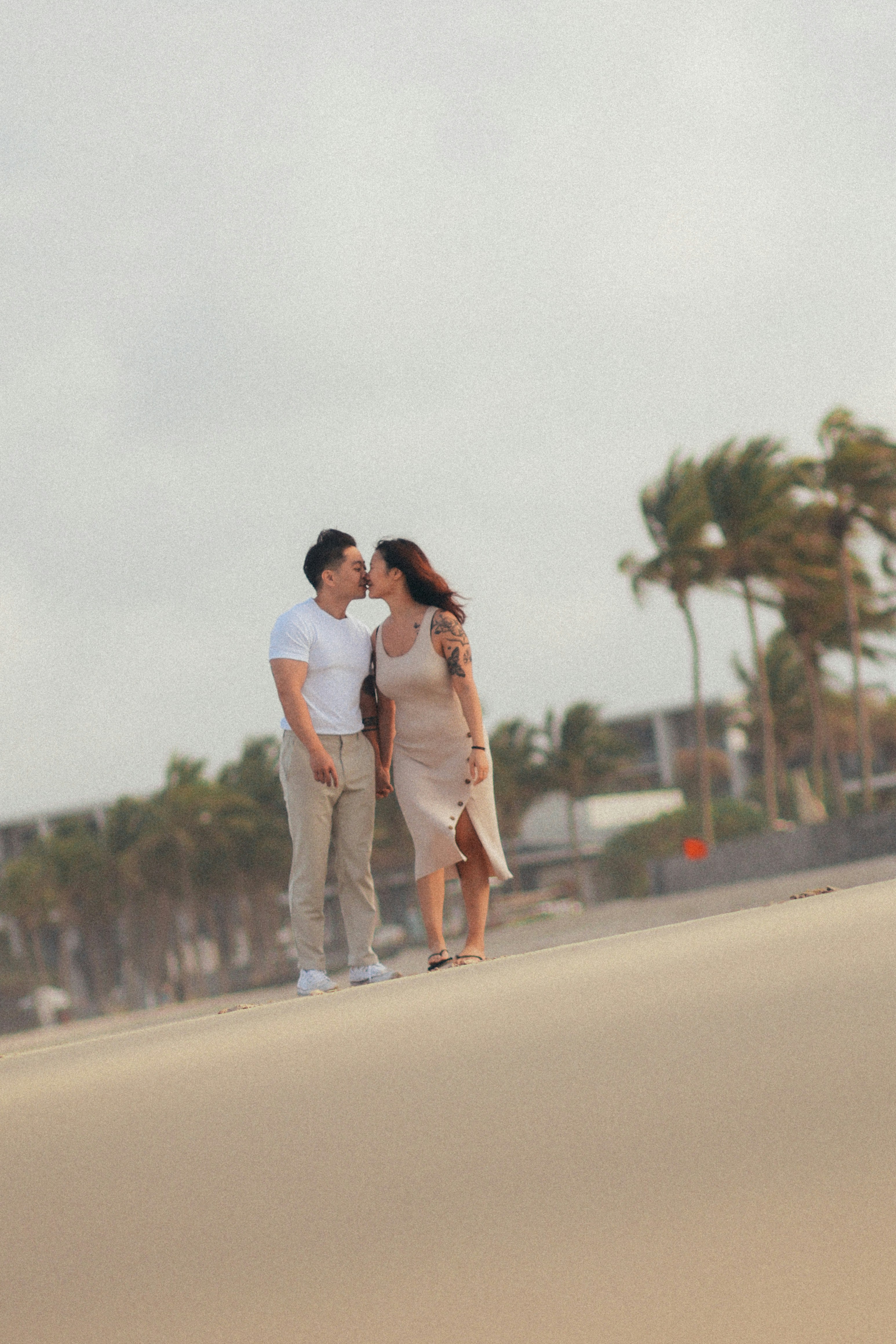Kiss on the Dune: A Wind-Swept Moment at the Beach