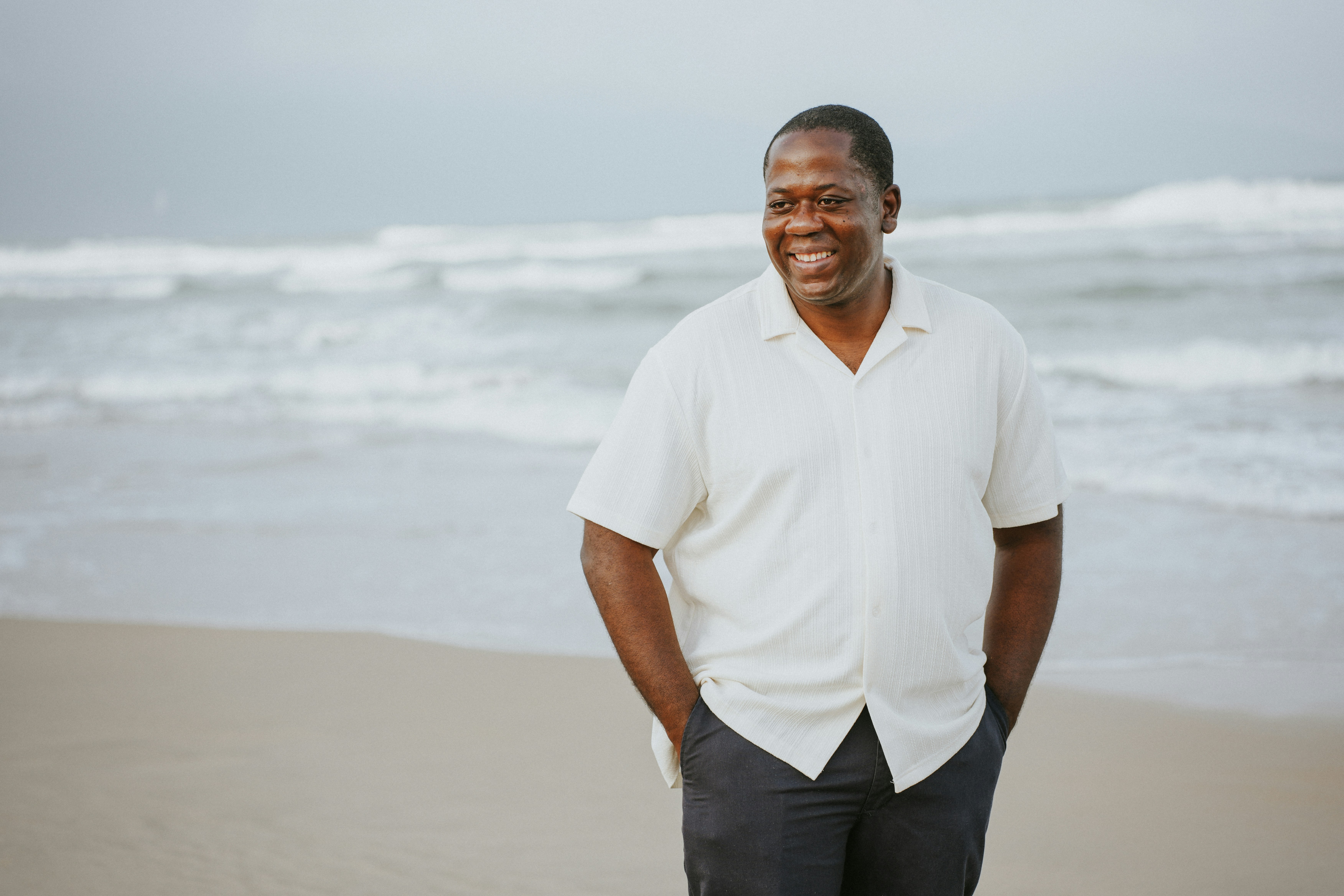 Coastal grin: a relaxed portrait on the shoreline