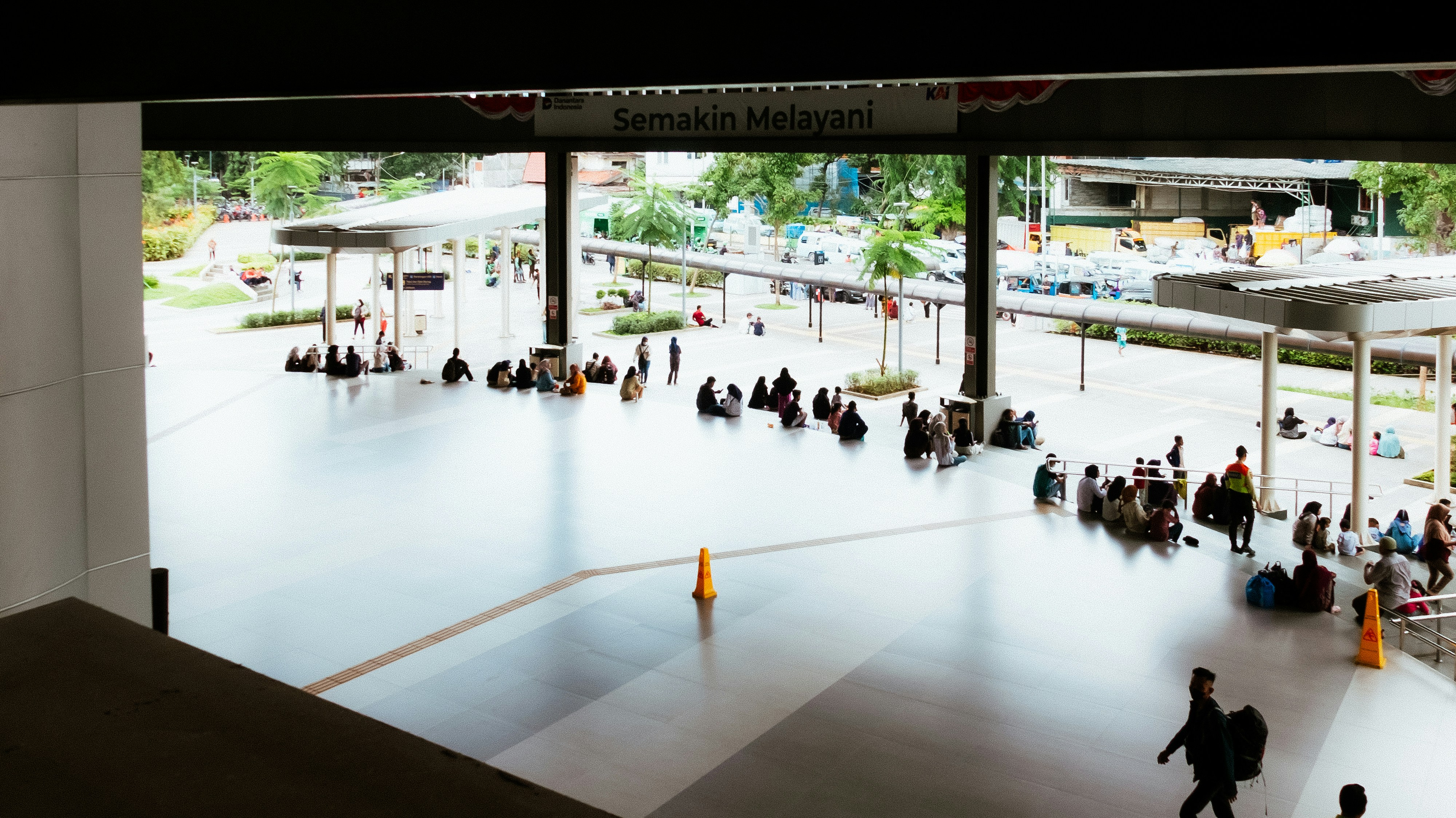 Open Courtyard Rally: A Quiet Assembly Under a Shaded Overhang