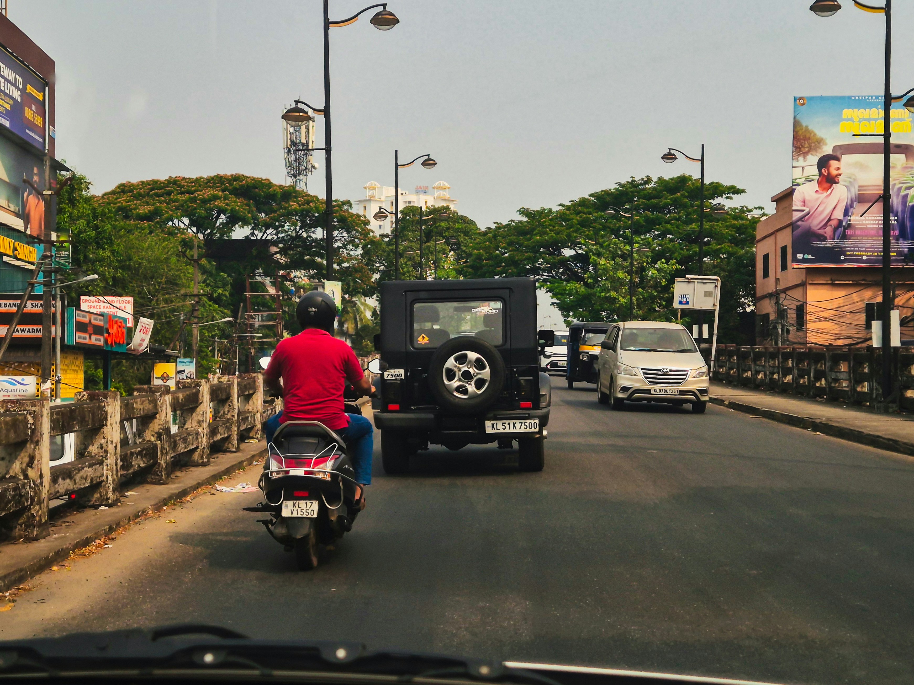 Lane of Traffic: A Red-Backed Rider in the Center Lane