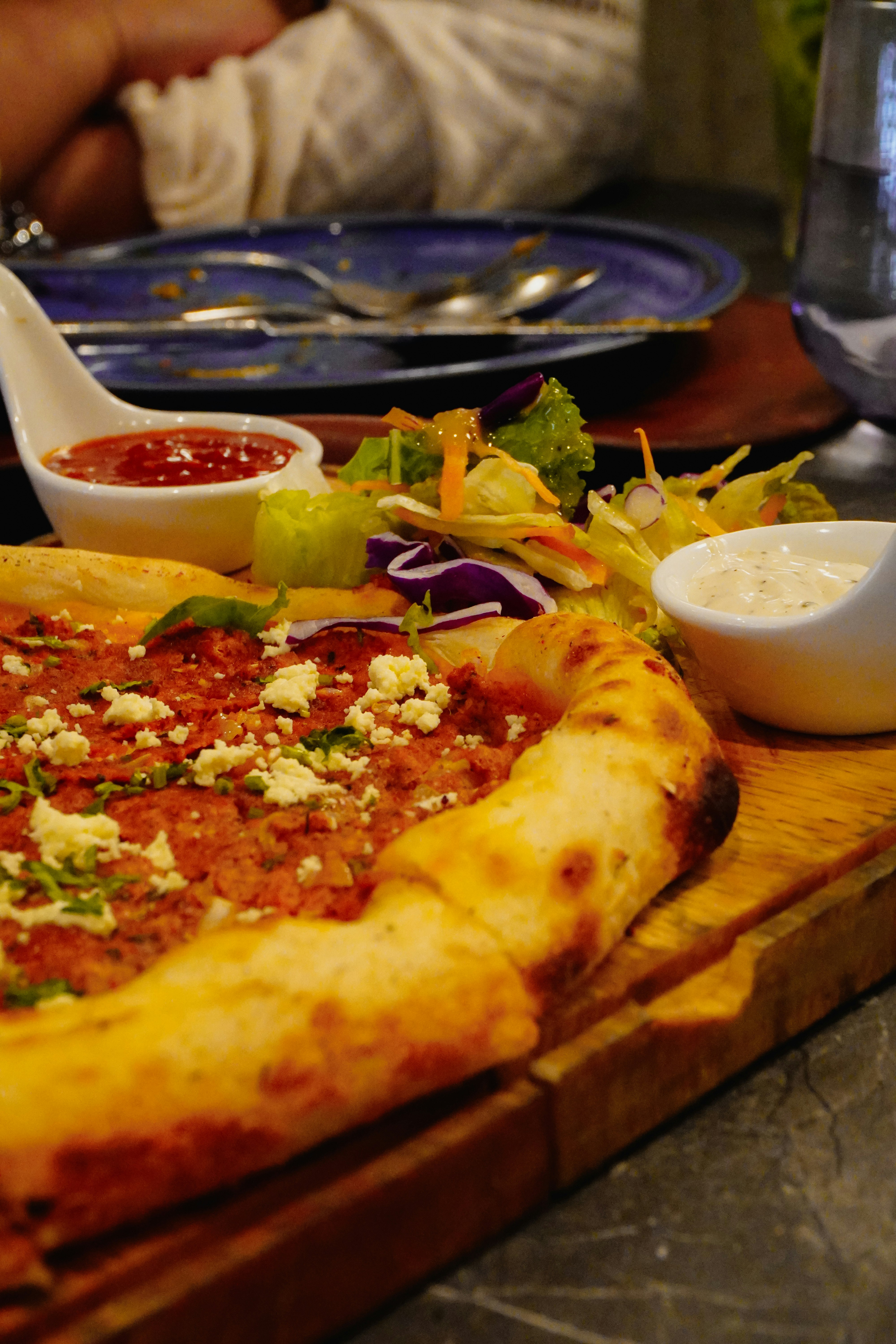 Wooden-board Pizzeria: A Sizzling Pizza with Fresh Greens