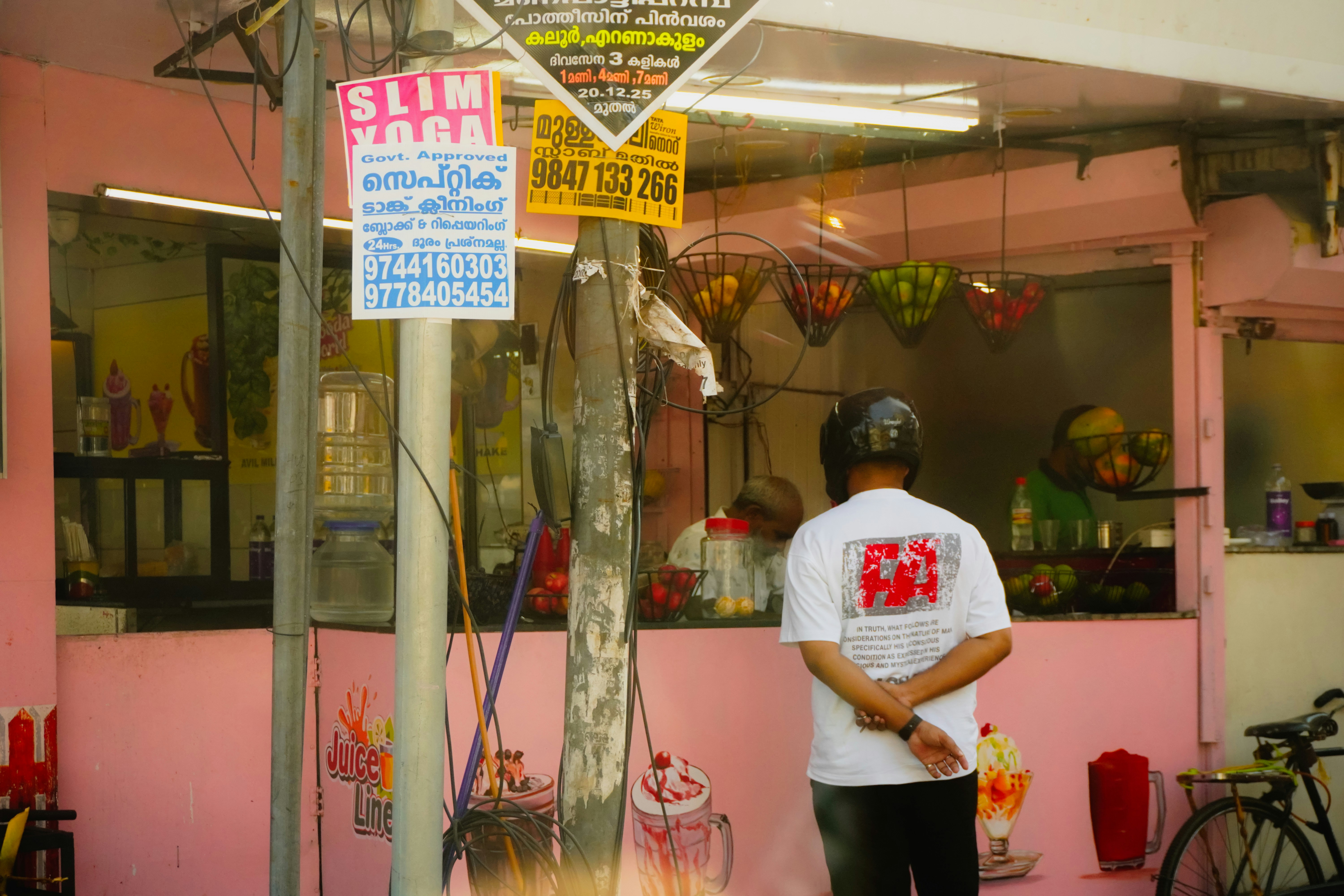 Behind the Pink Counter: A Quiet Moment at the Market Stall