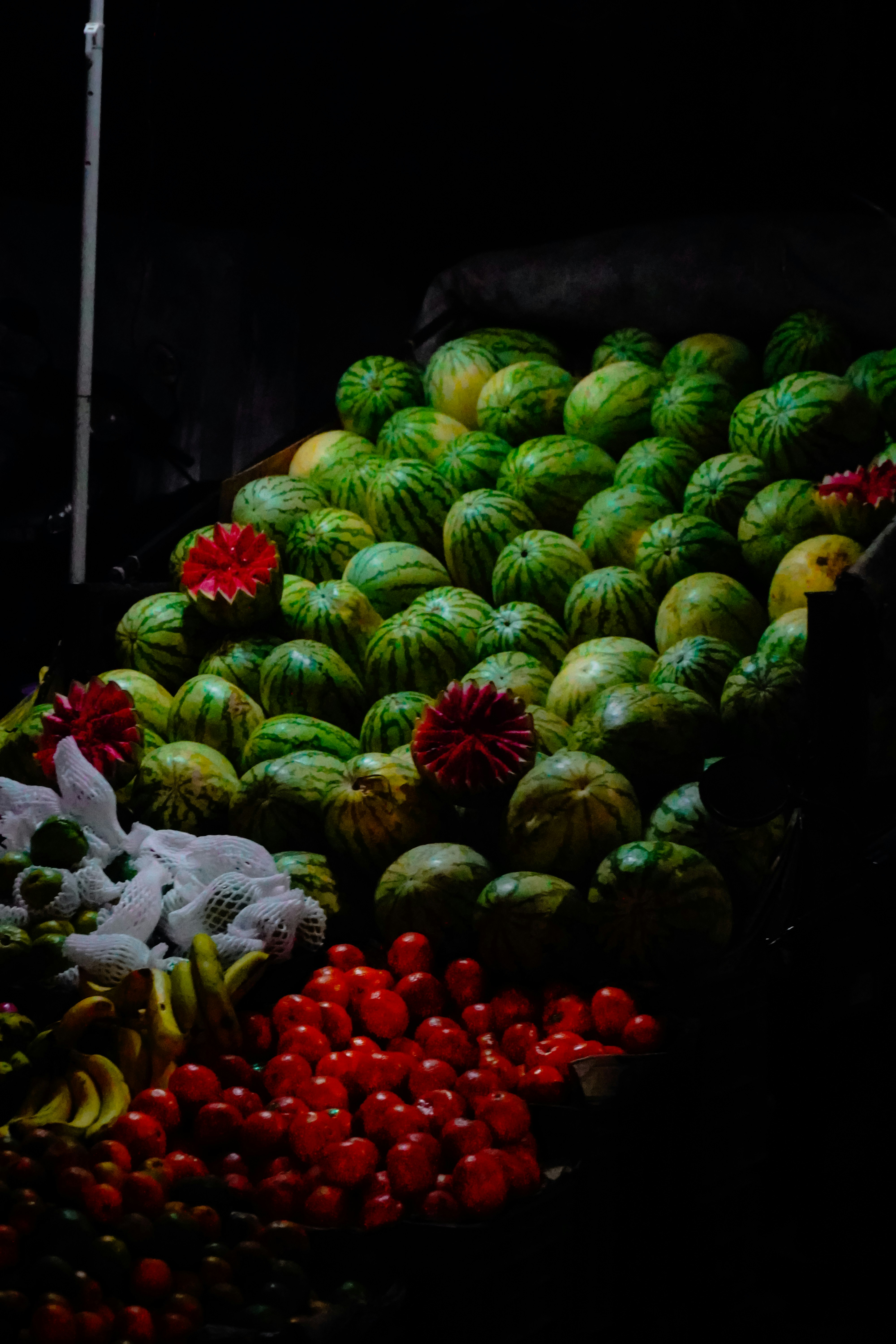 Watermelon Market Glow: A Night Stall of Green Orbs and Red Orbs