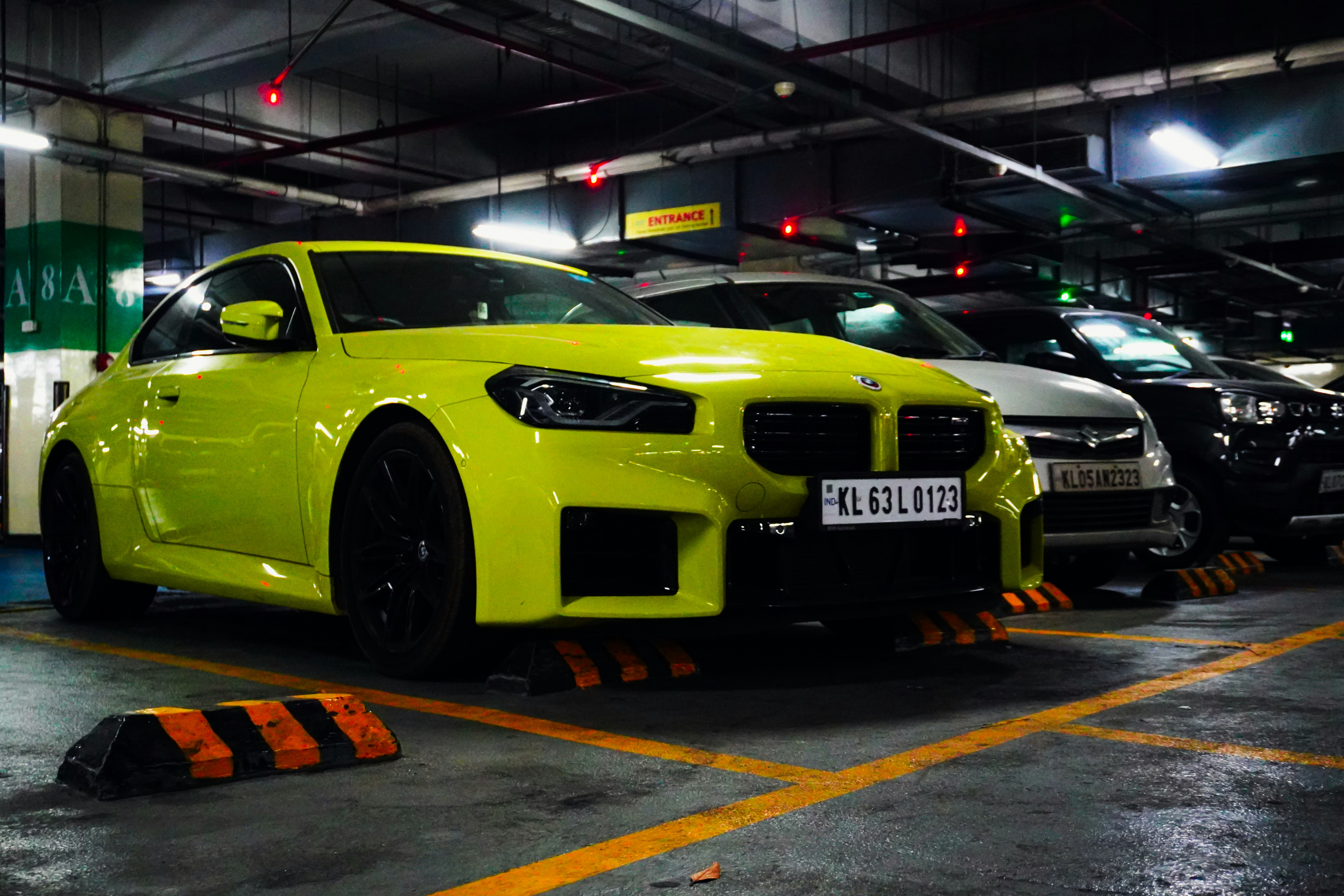 Neon Challenger: A Yellow Sports Car Anchors a Dim Parking Garage