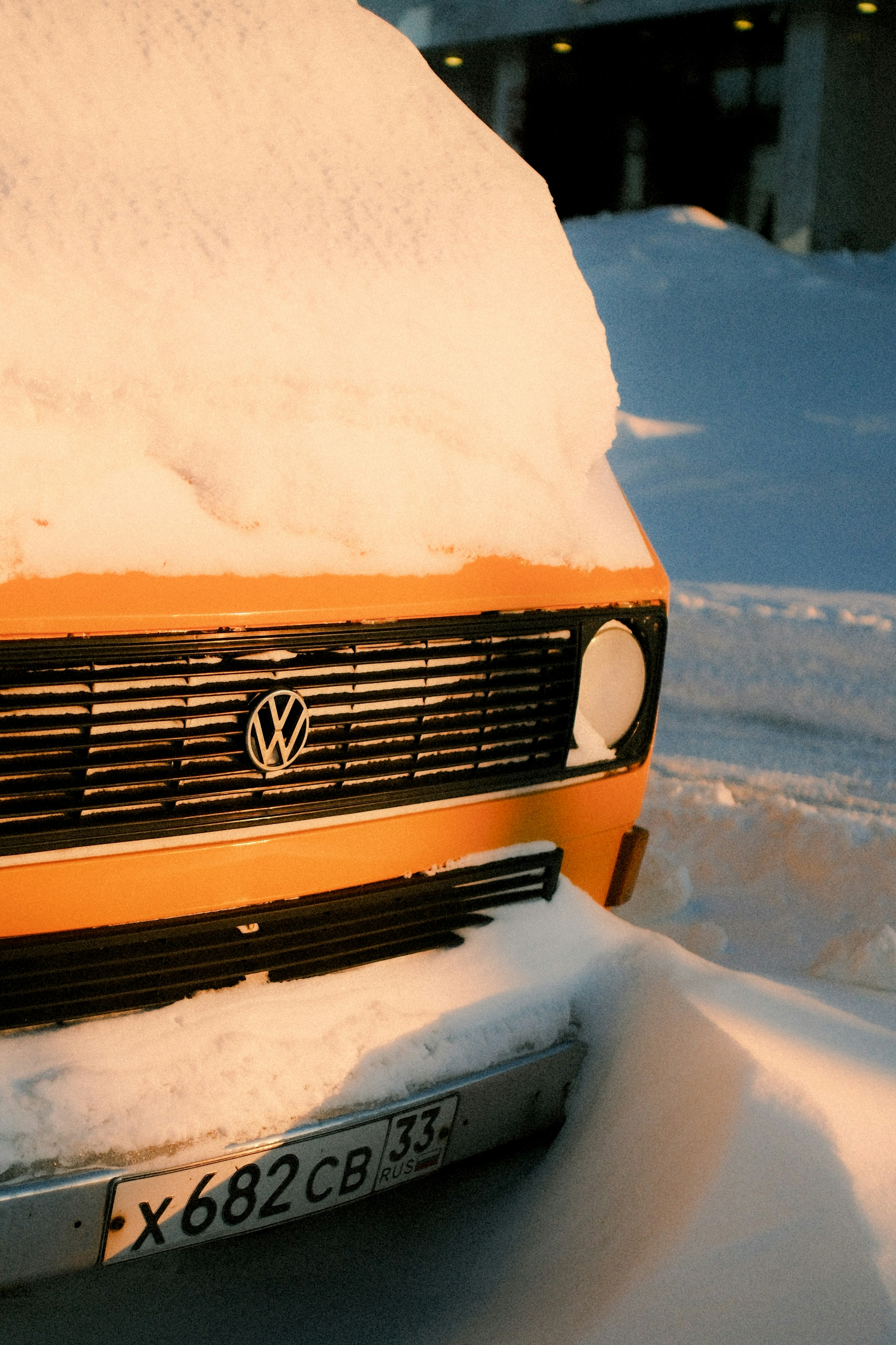 Snowbound VW Front: Orange Car Buried in Winter Snow
