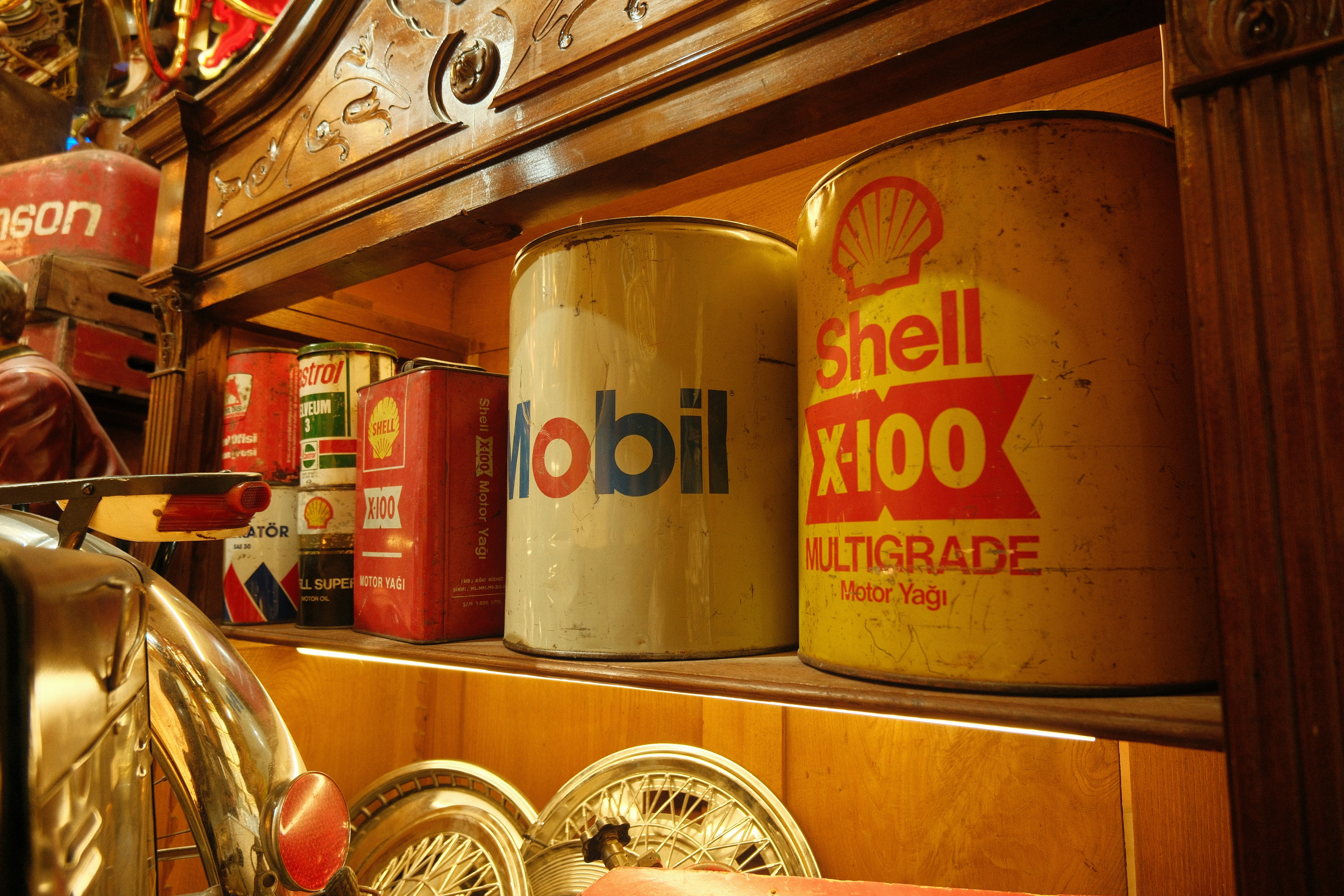 Vintage mobil and shell oil cans on a shelf