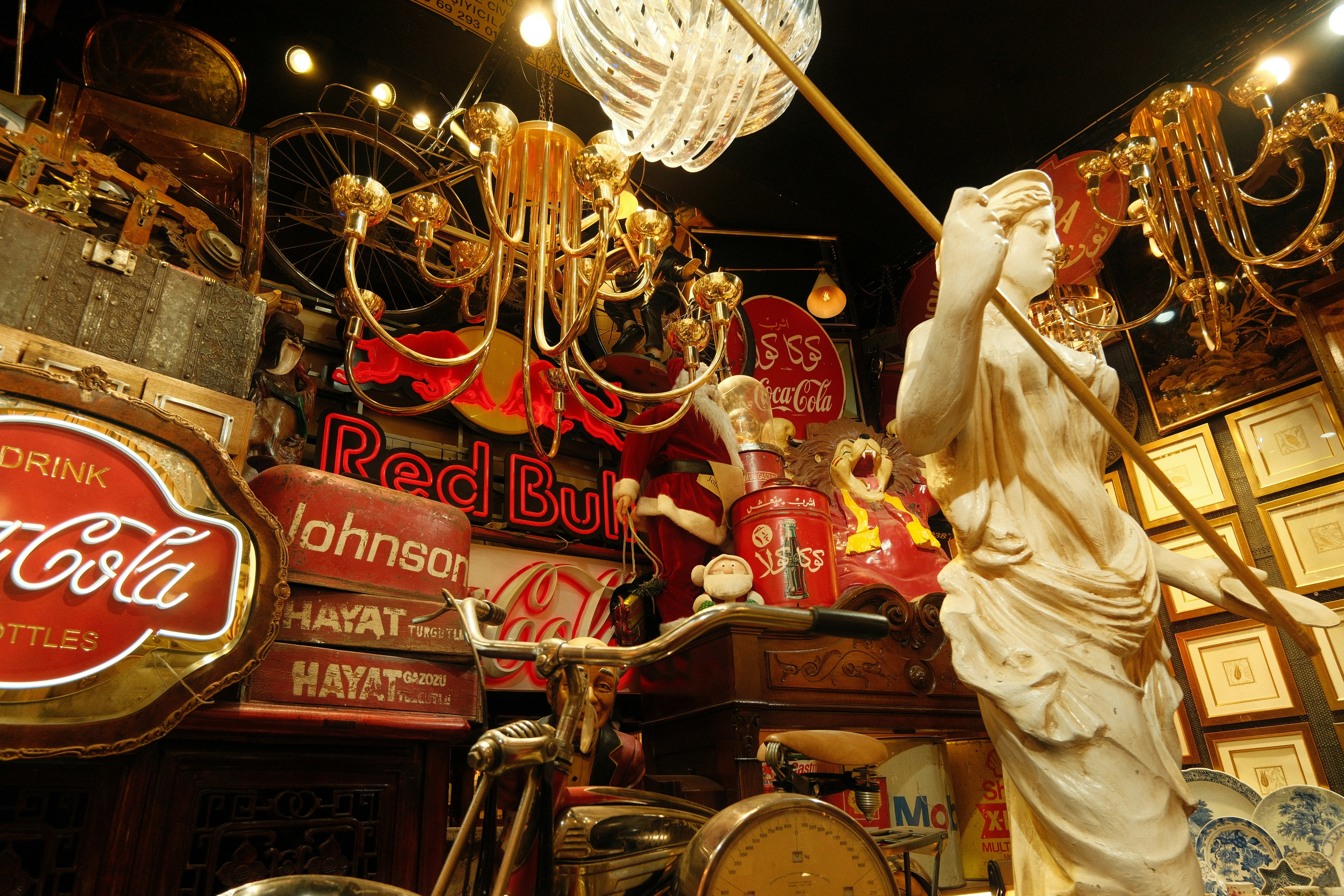 Ornate antique shop filled with vintage signs and statues