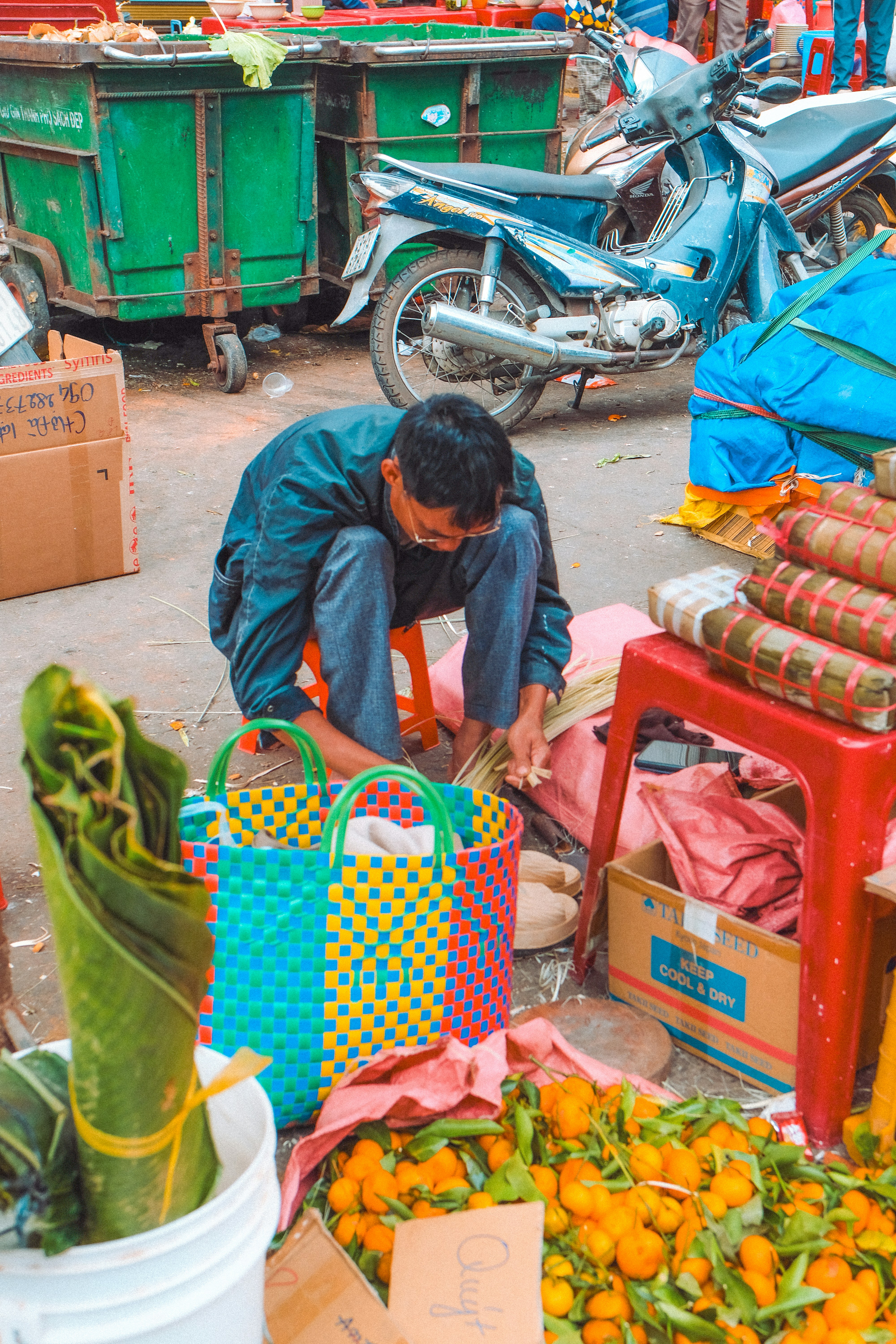 Market Vendor at Work: Hands Busy with Fresh Produce