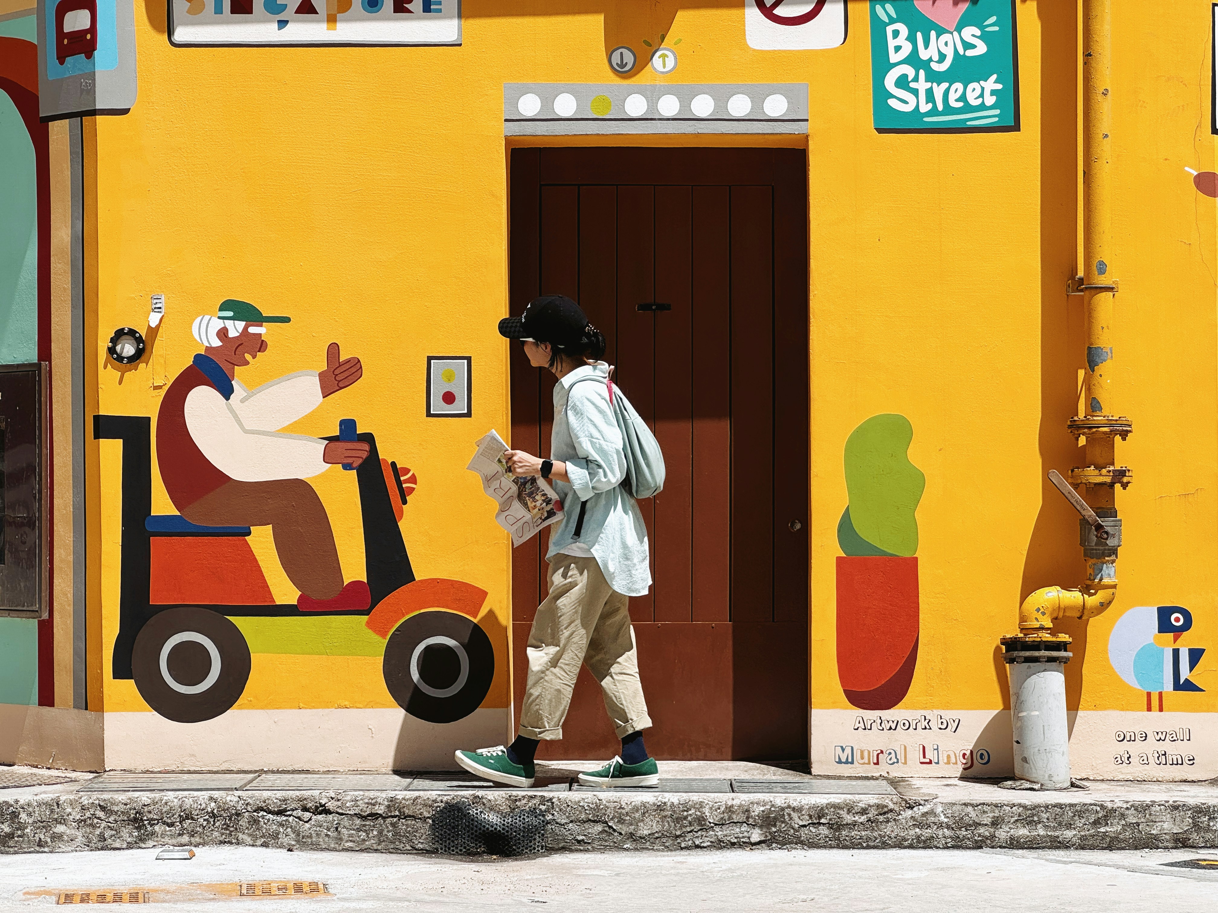 Pedestrian in front of a mural doorway