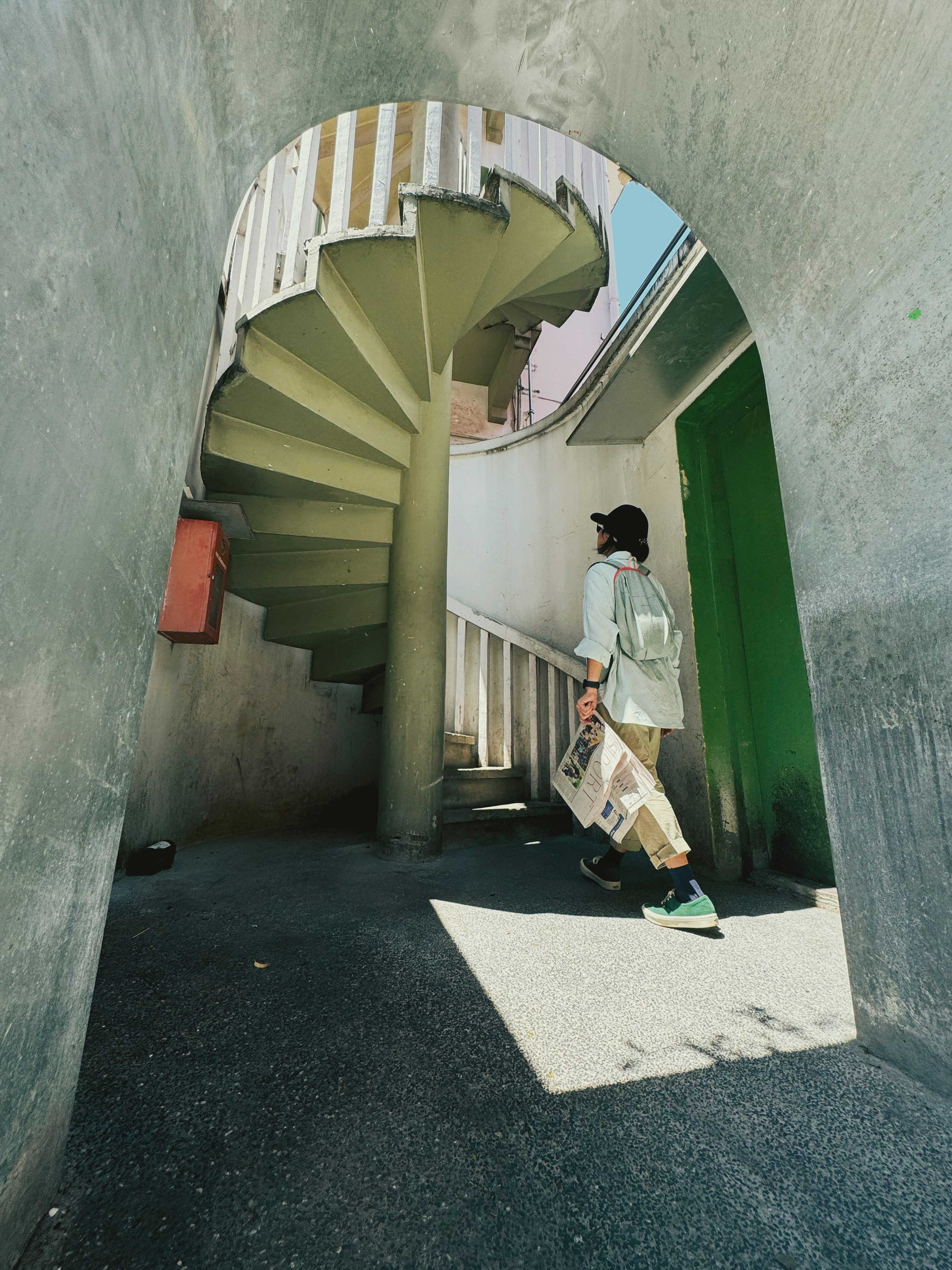 Curved Staircase Echoes in a Sunlit Archway
