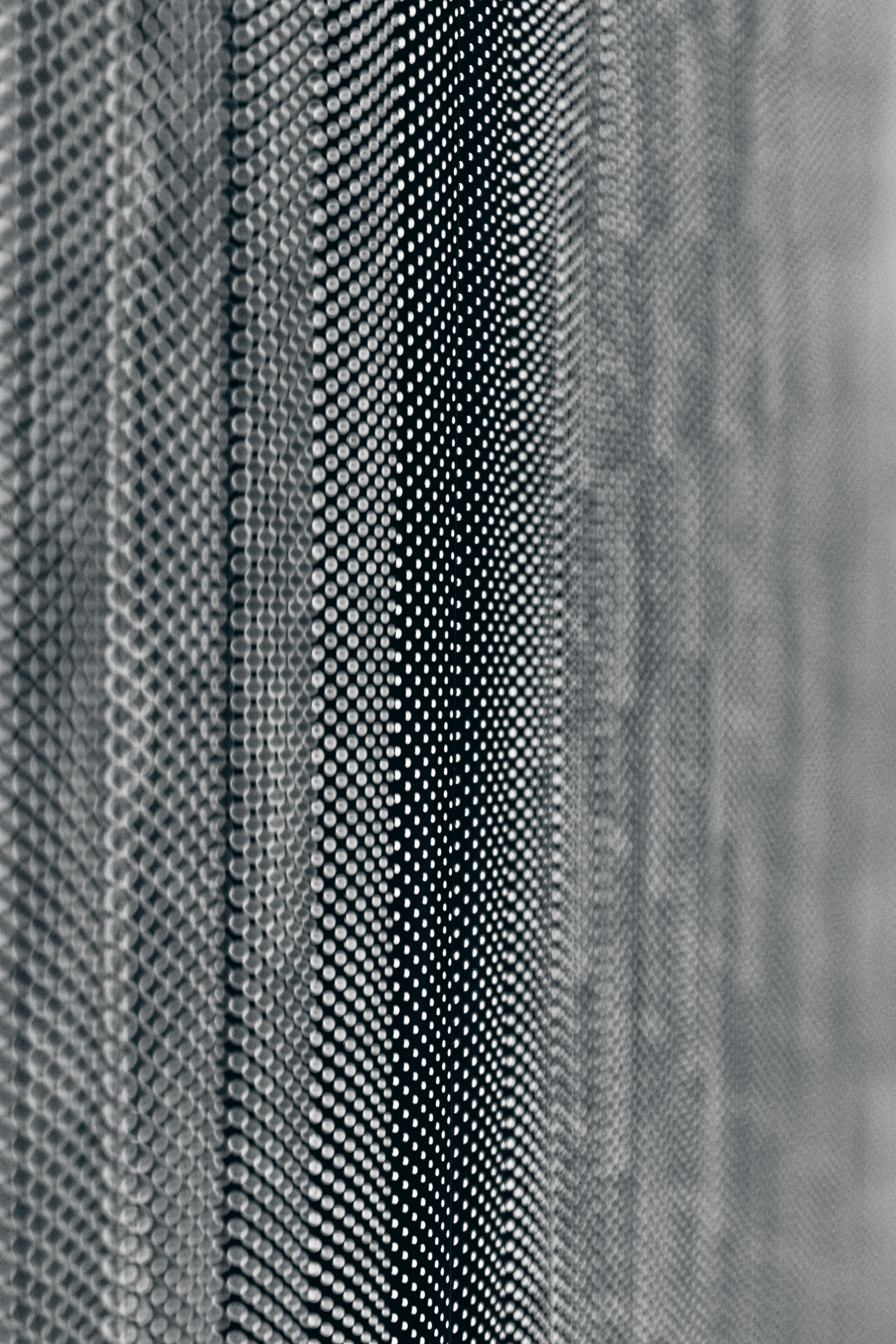 Textured Silence: Grayscale Dots in a Curtain of Light