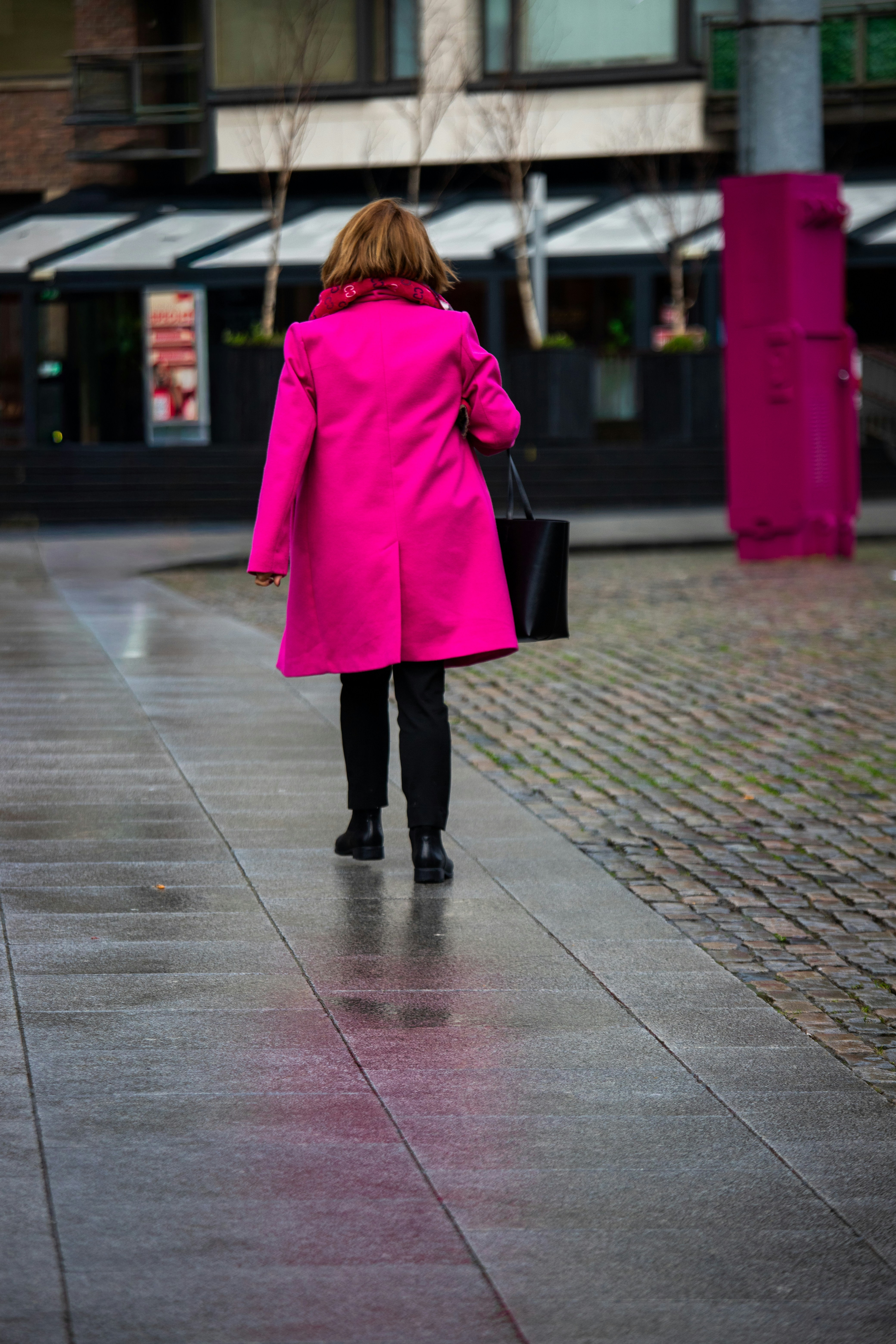 Magenta Trench Coats in a Wet Urban Evening