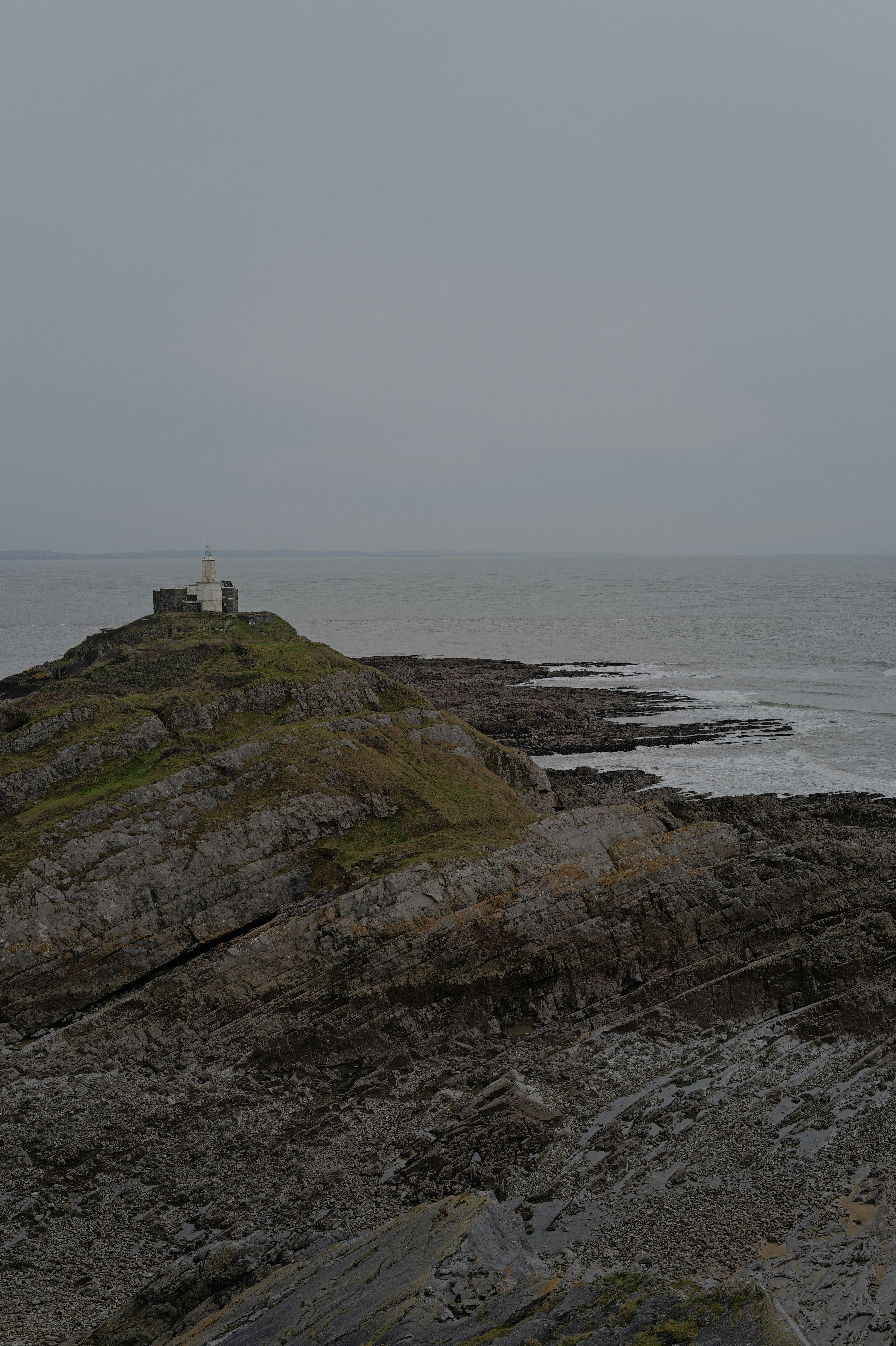 Lighthouse on the Promontory: Quiet Sentinel Over the Tidal Plain