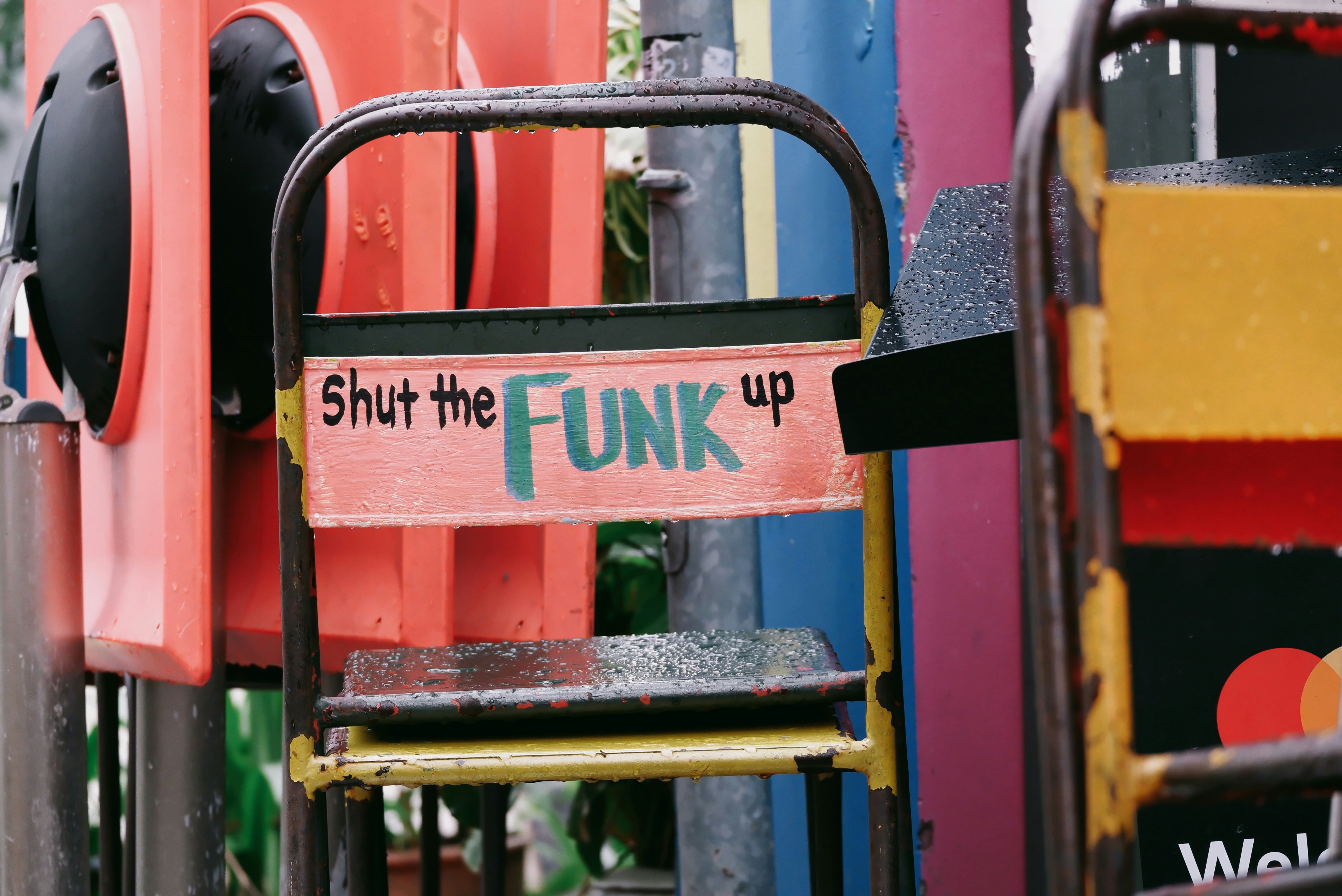 Shuttered Color: A Chalk Sign Among Playground Rigs
