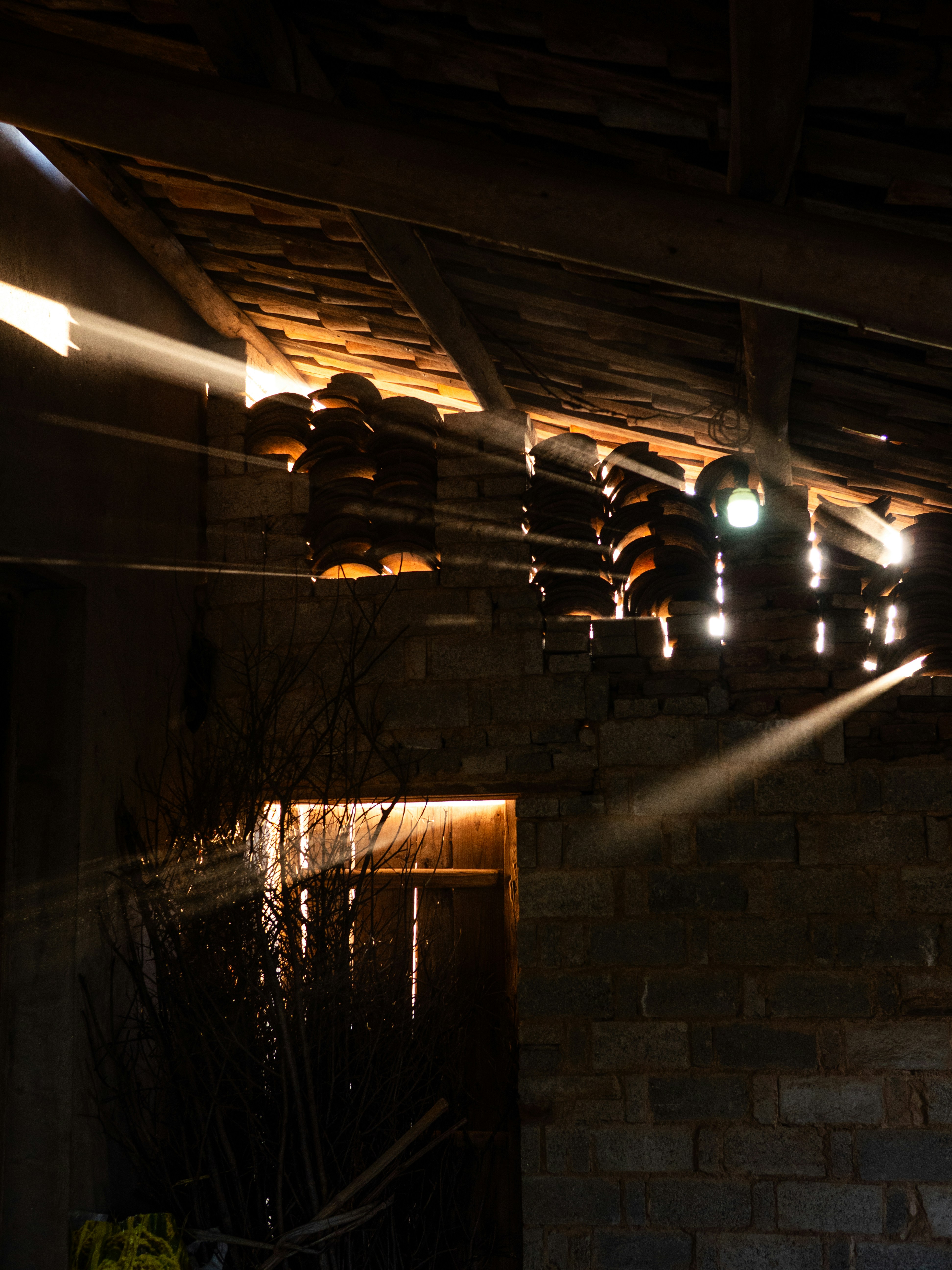 Sunlit Gaps and Timber Beams in a Dim Workshop
