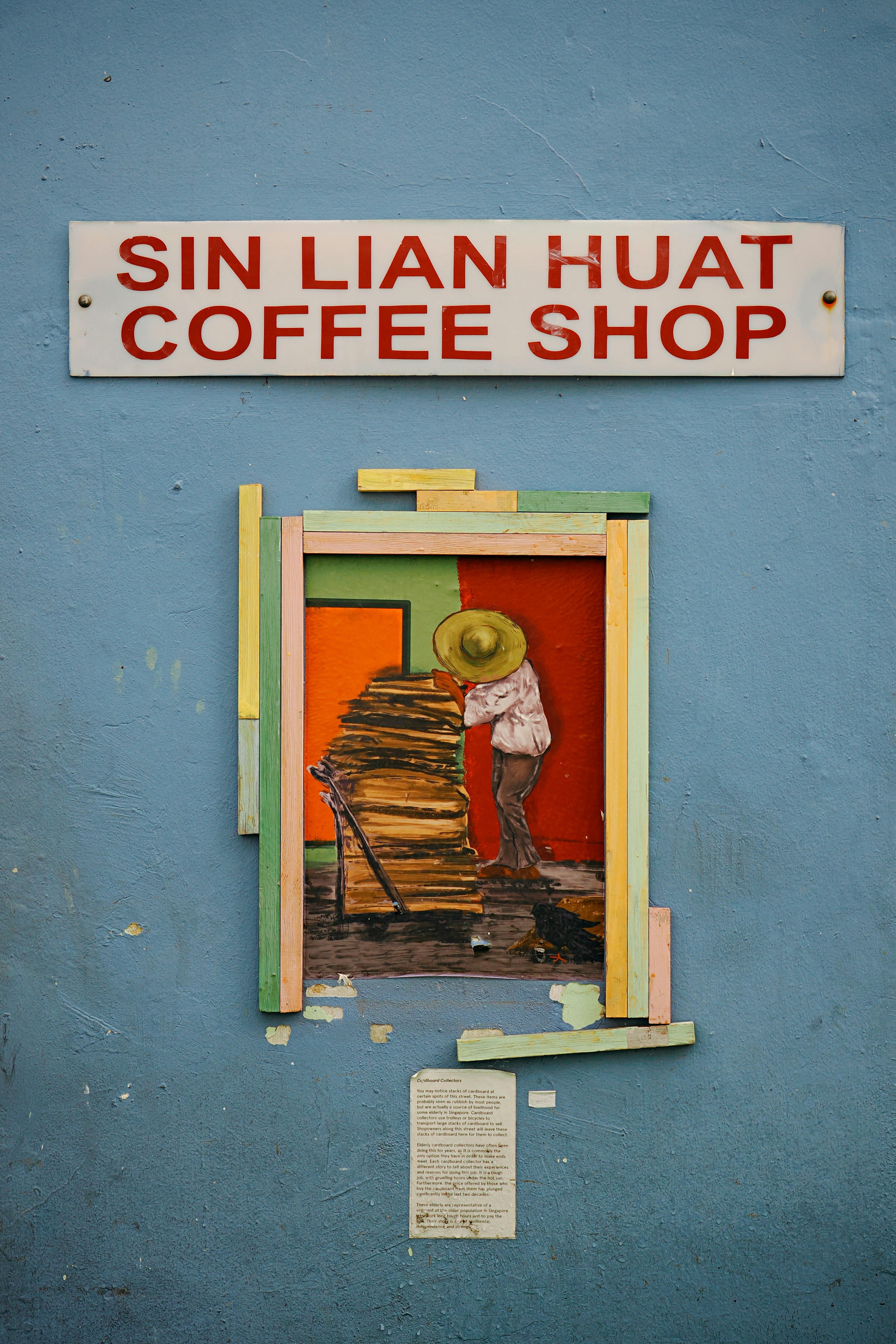 Colorful Frame Within a Frame: A Nomadic Coffee Sign Beside a Painted Portrait