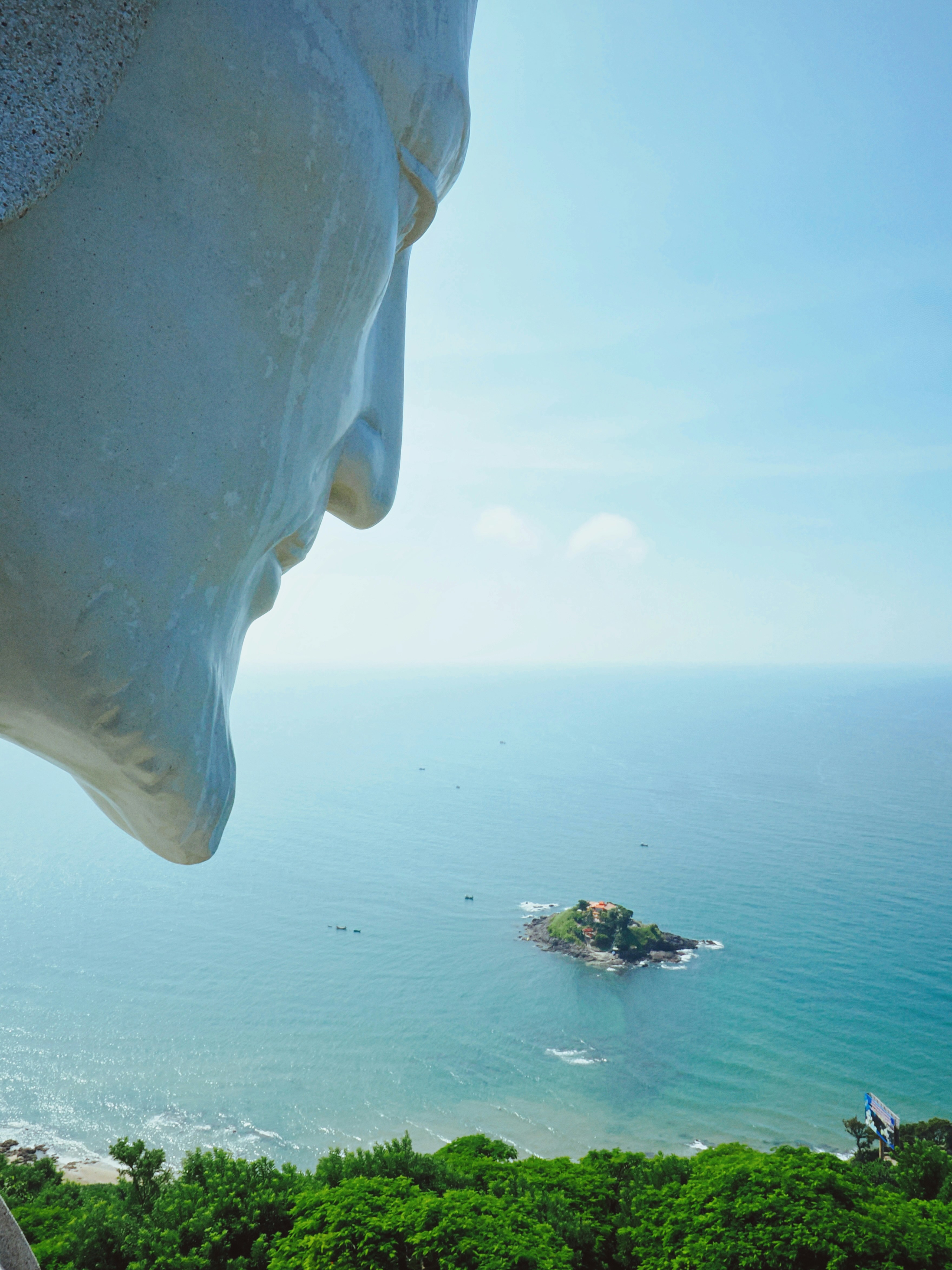 Gaze Over the Sea: A Stone Head against a Quiet Horizon