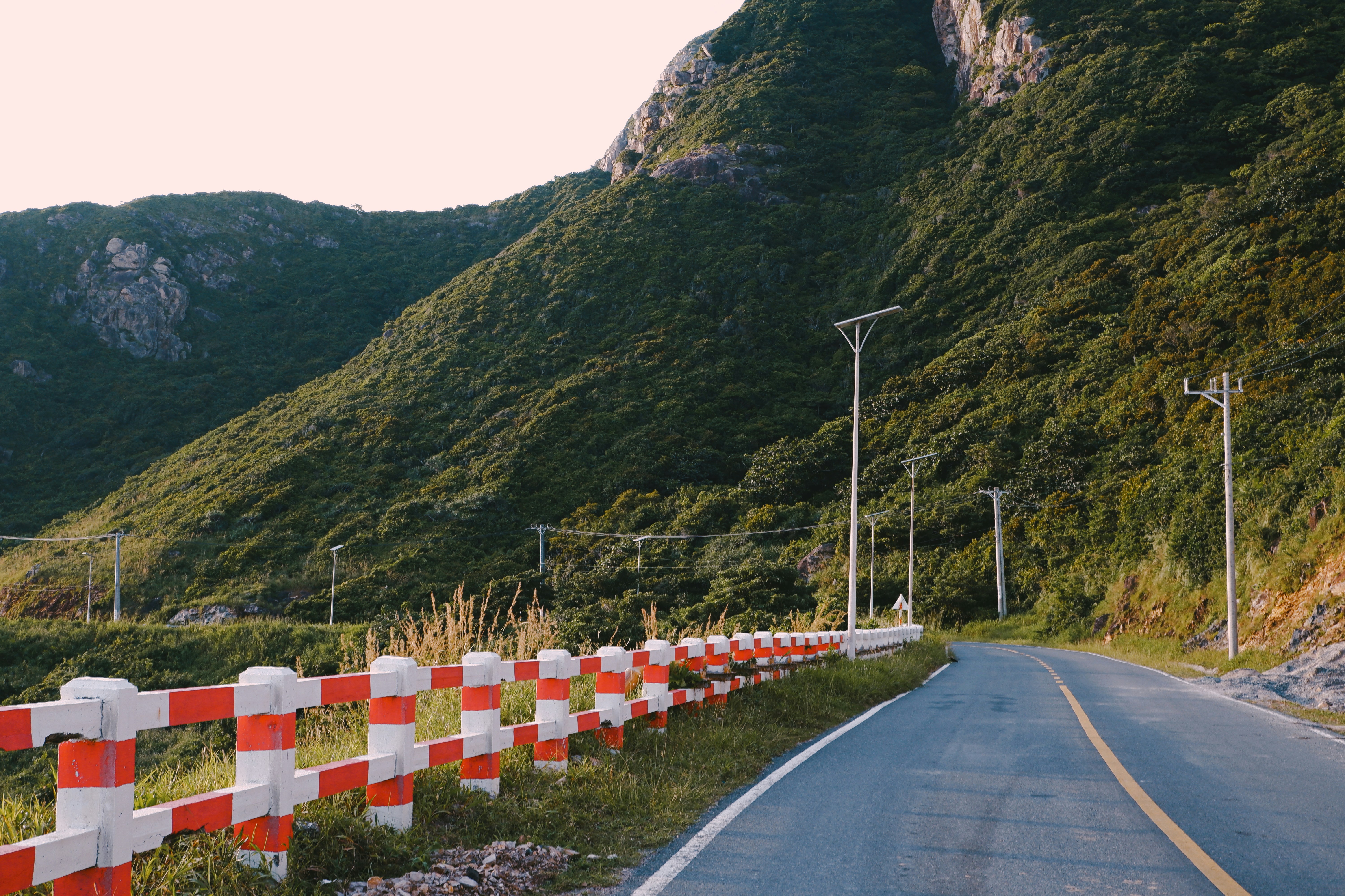 Mountain Road Echoes: A Quiet Descent Between Barriers and Peaks