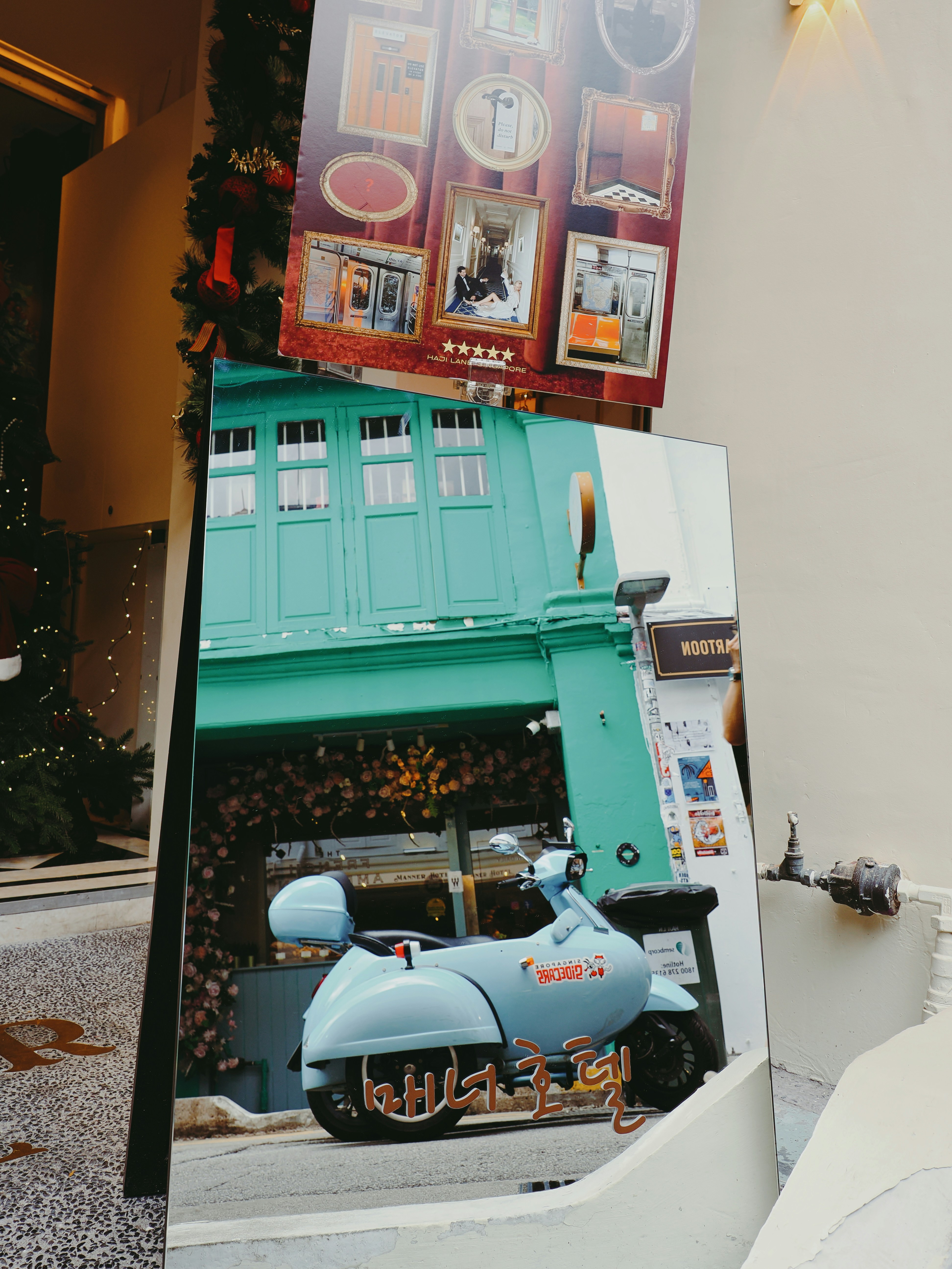 Urban Echo: A Leaning Cardboard Scene of a Teal Facade and Vintage Scooter