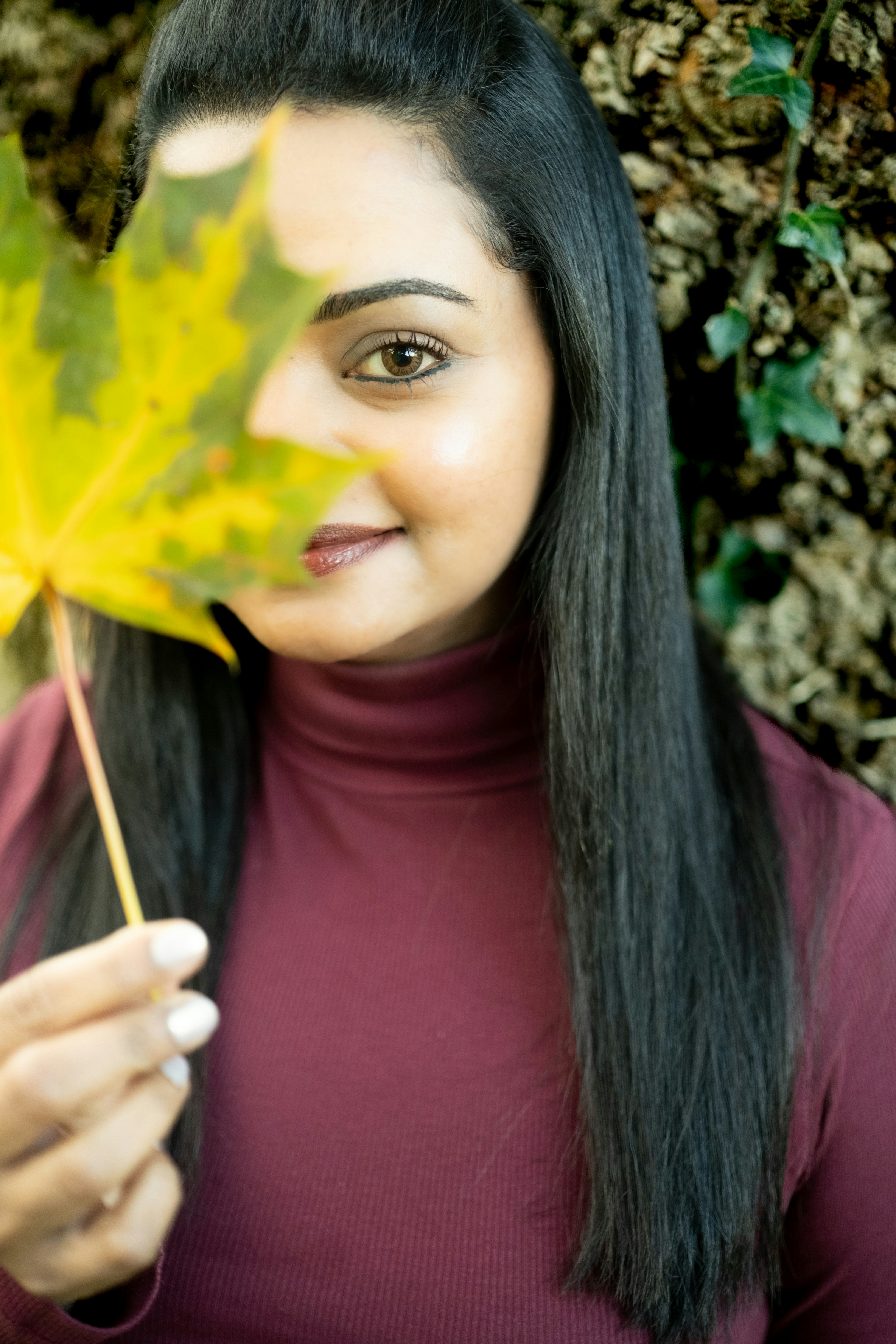 Hidden Smile: Portrait with Leaf Obscuring the View