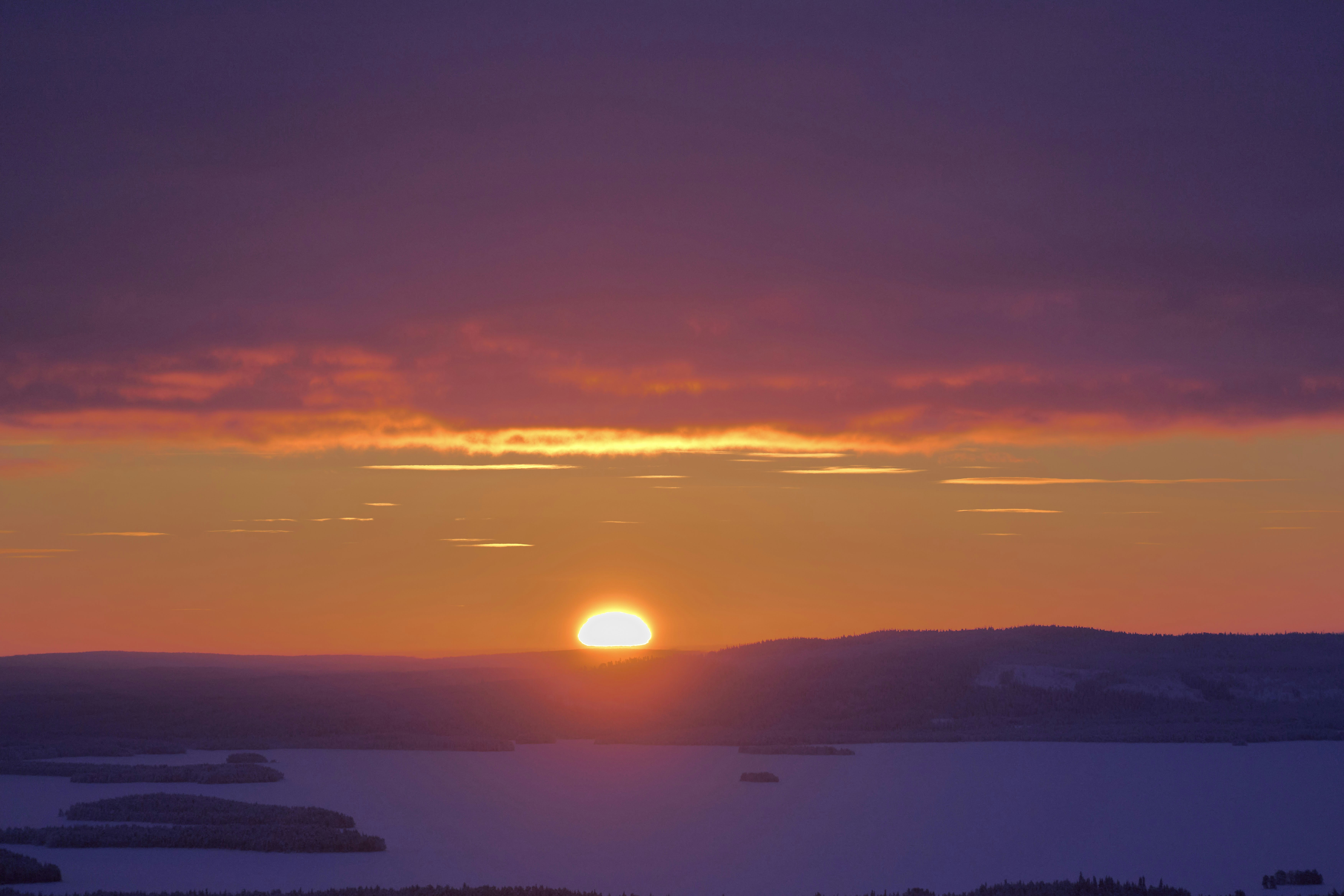 Solar Disc at Dusk Over Quiet Inland Waters
