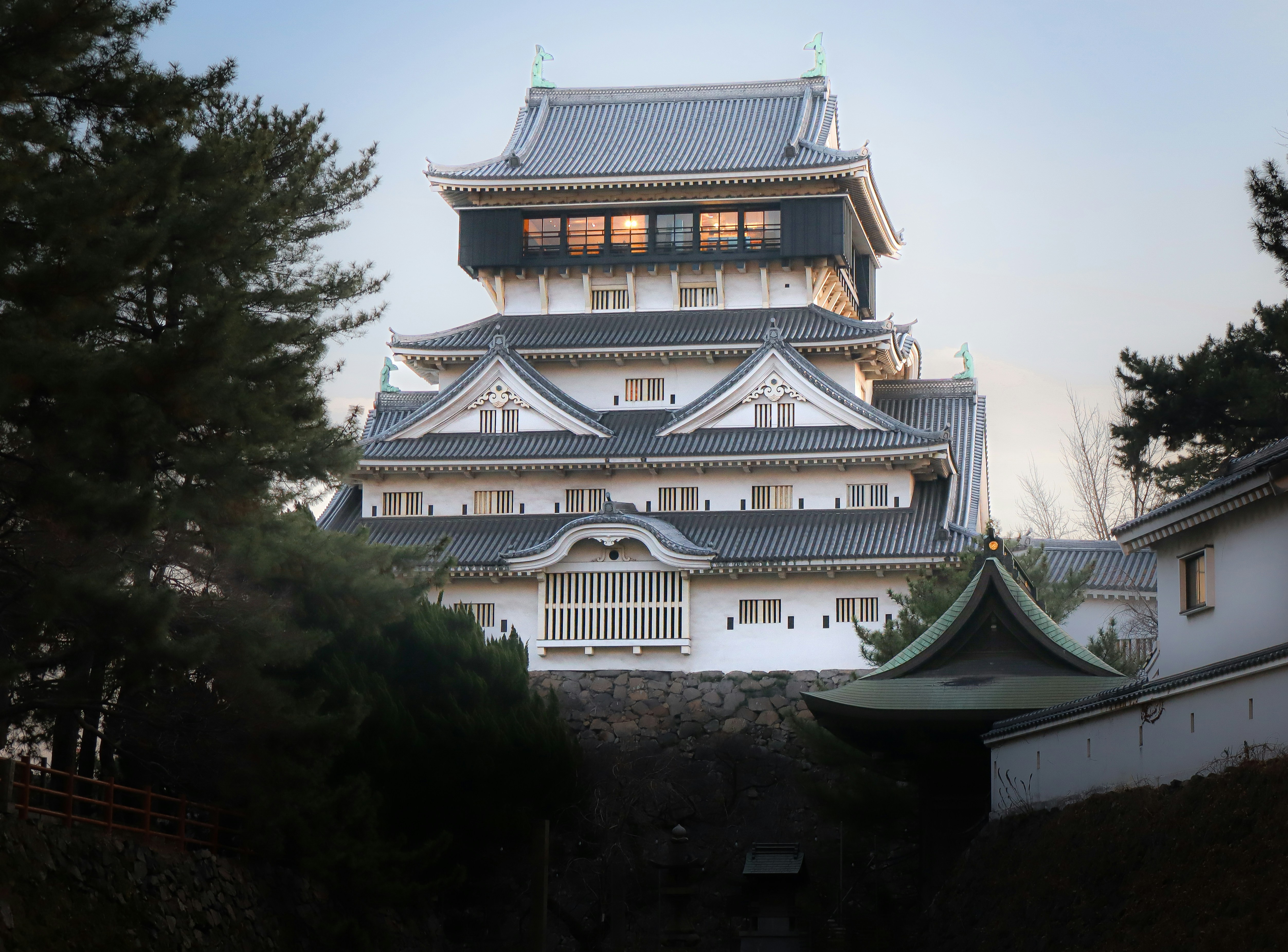 Moonlit Keep: A Japanese Castle Rising Above the Foliage