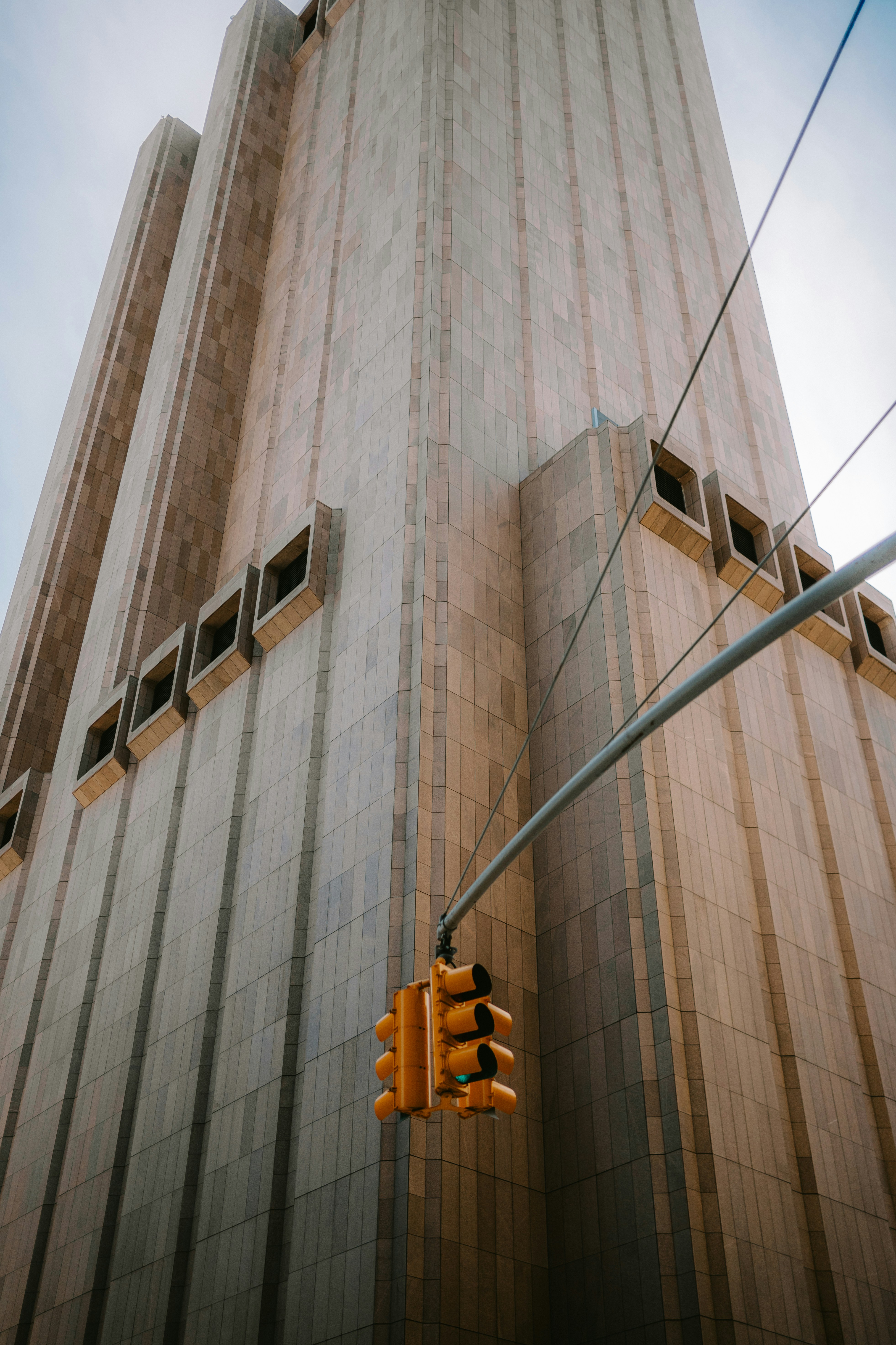 Towering Geometry and Red Signal: A Street-Level View of Vertical Concrete Facades