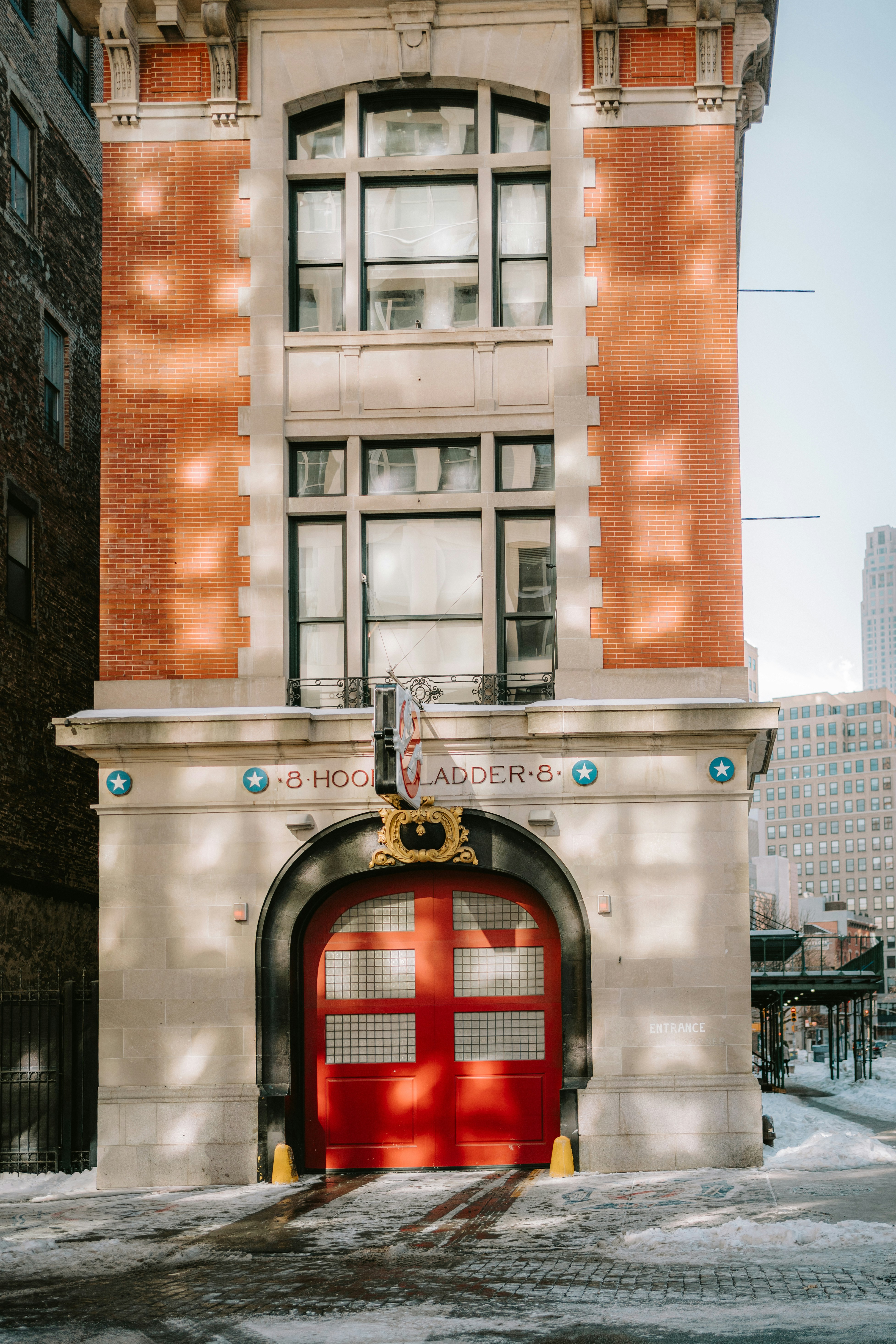 Firehouse Facade: Red Door Under the Crowned Crest