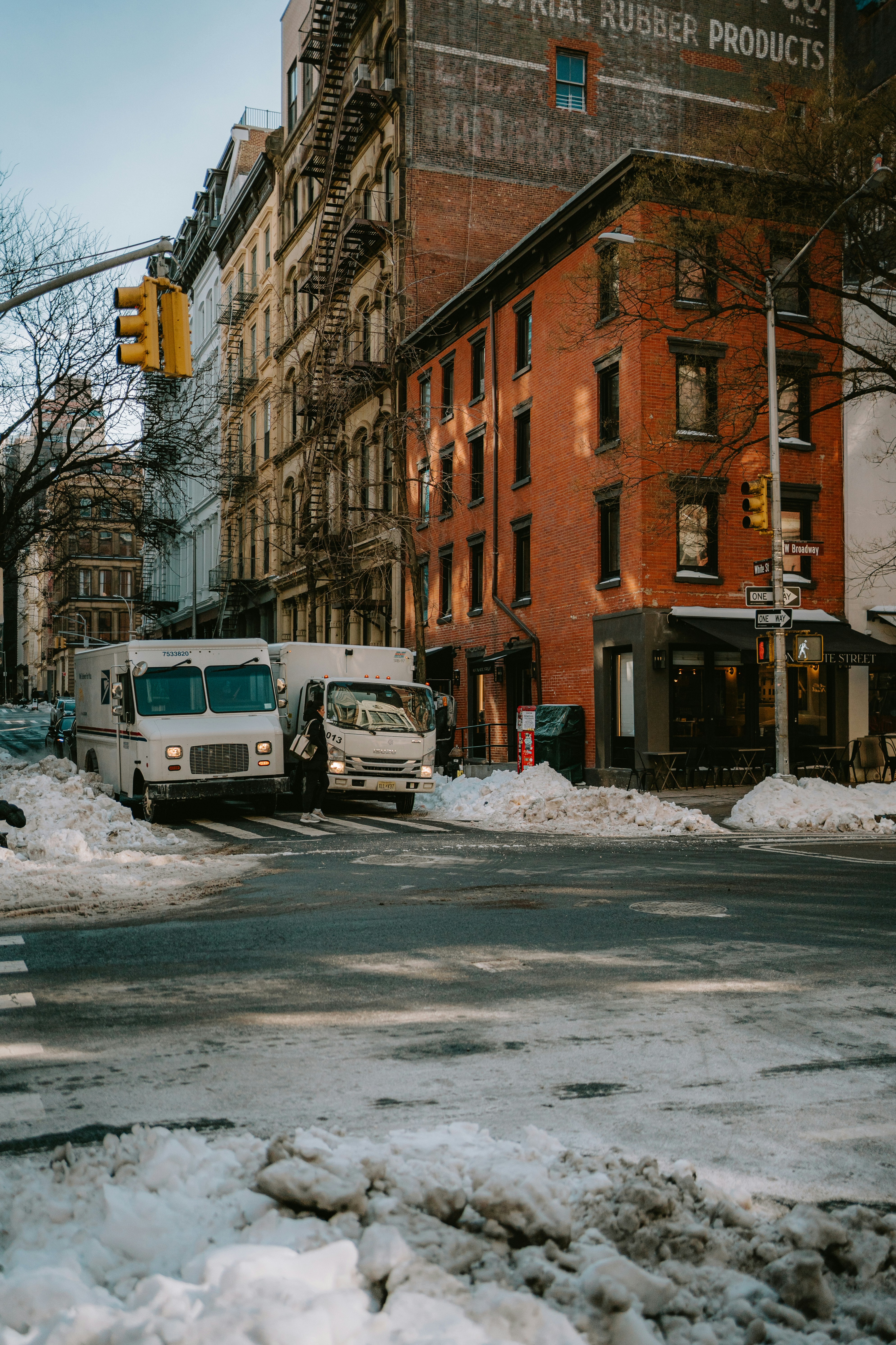 City Street in Snow: Trucks, Brick Facades, and Winter Quiet
