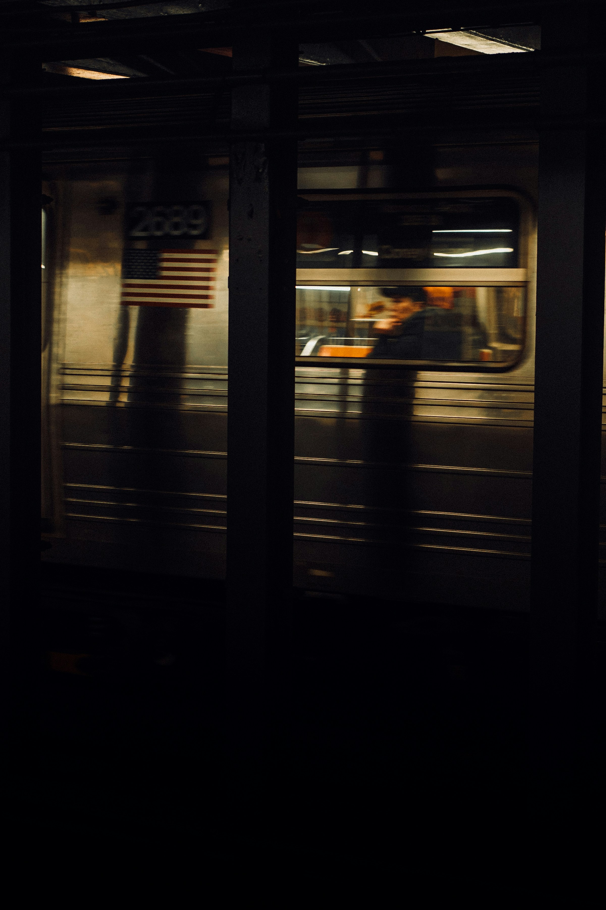 Subway Window: A Quiet Moment Through The Steel Frame