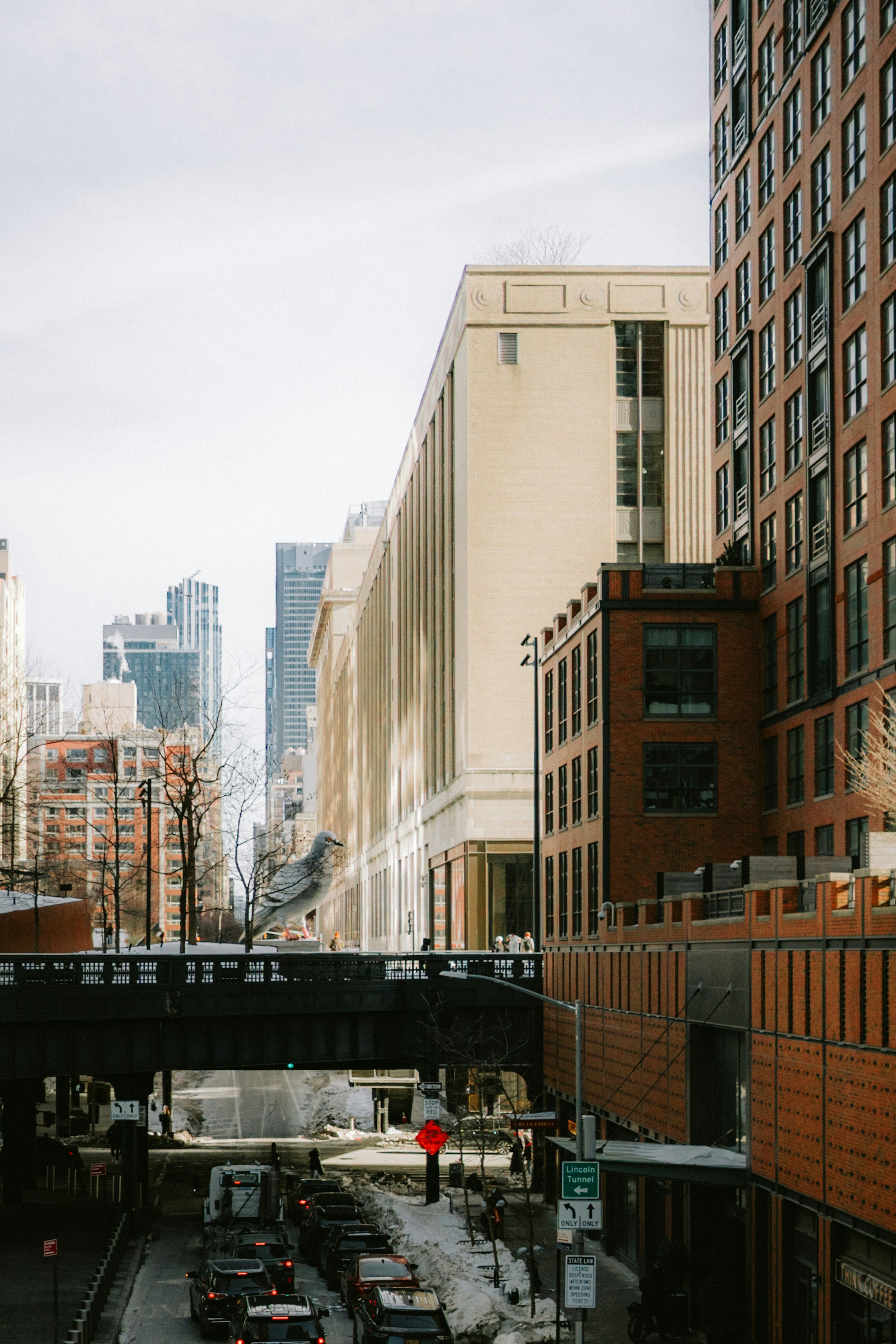 Urban Canyon: Light, Glass, and Brick Along a Snow-Dusted Street